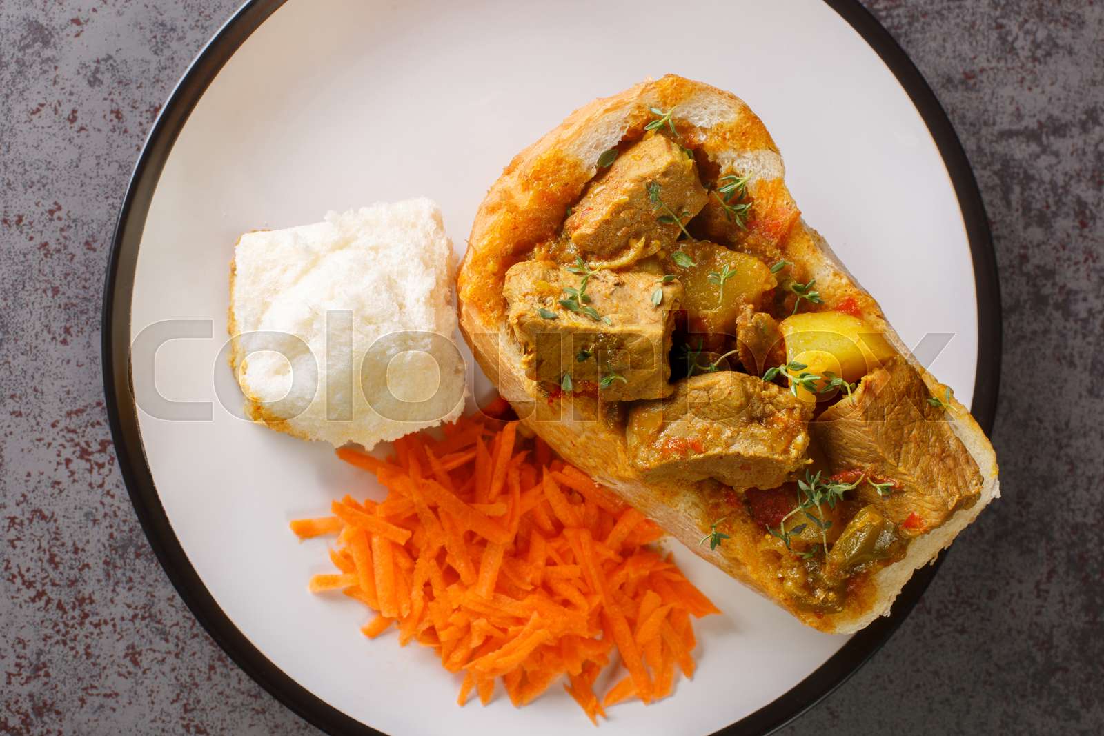 traditional durban mutton bunny chow closeup on plate. Horizontal top ...