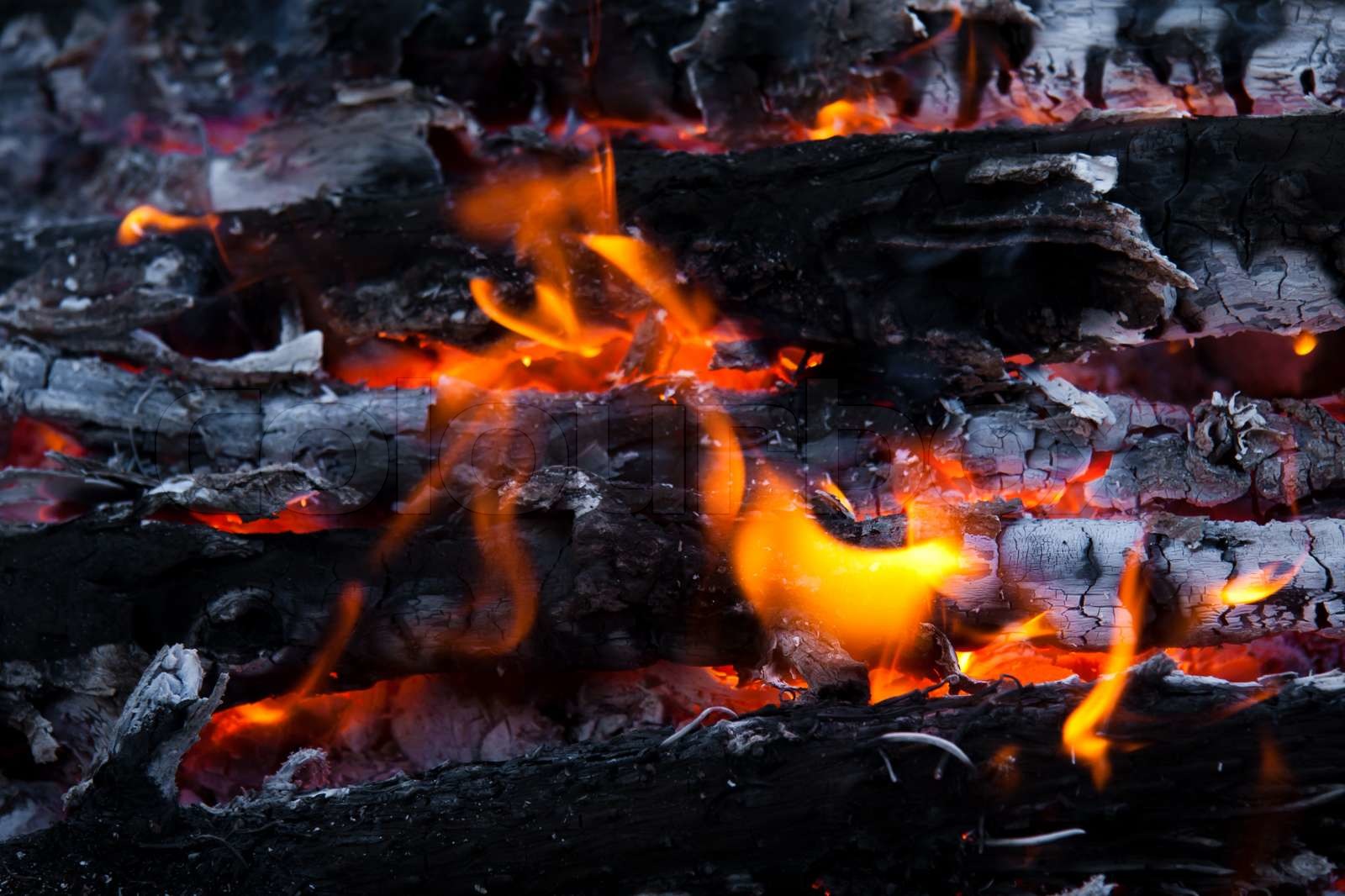 Burning wood and coal in fireplaceCloseup of hot burning wood, coals ...