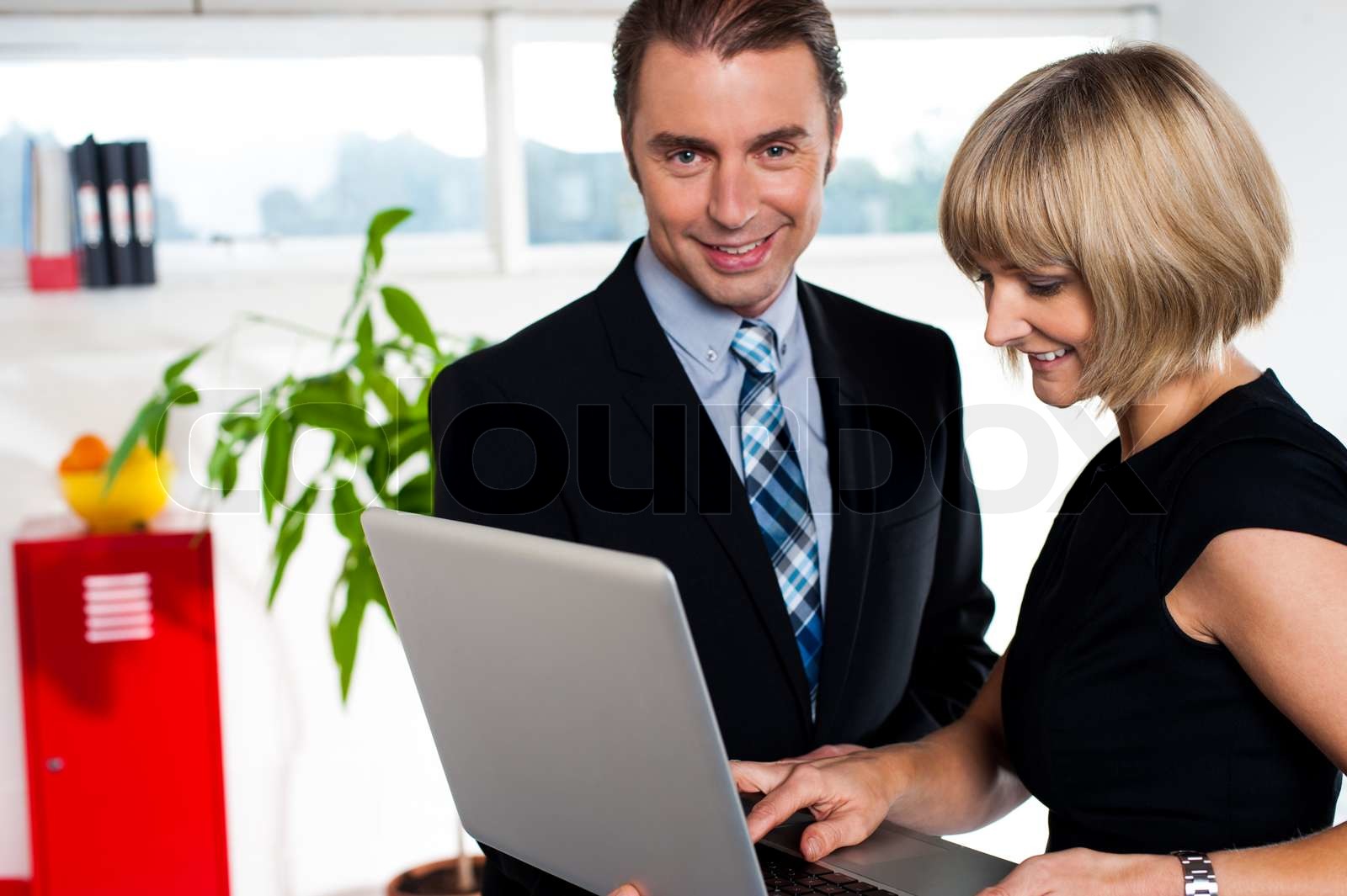 Secretary showing power point presentation to the boss | Stock image ...