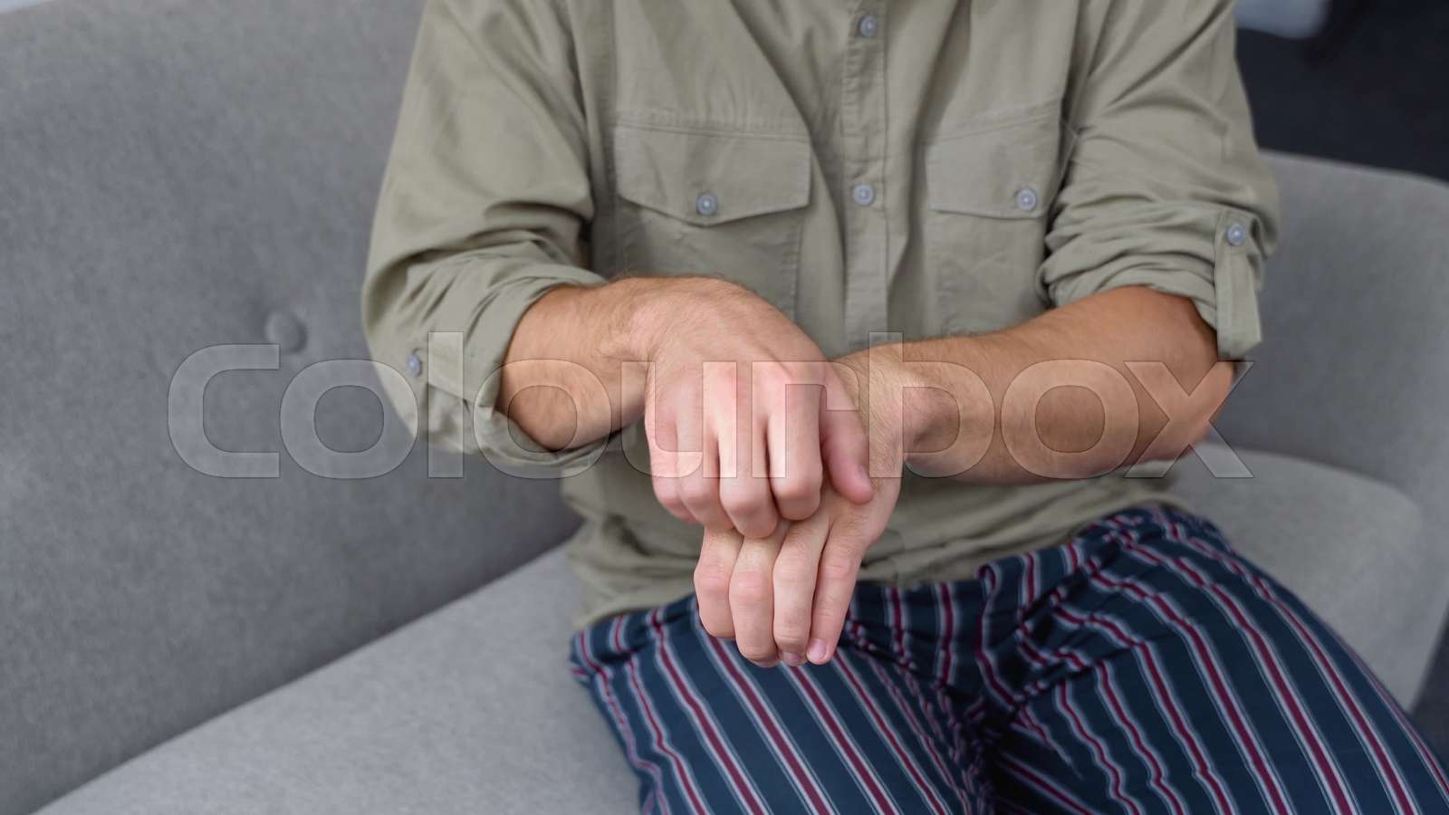 Close-up of young man scratching his hand | Stock video | Colourbox