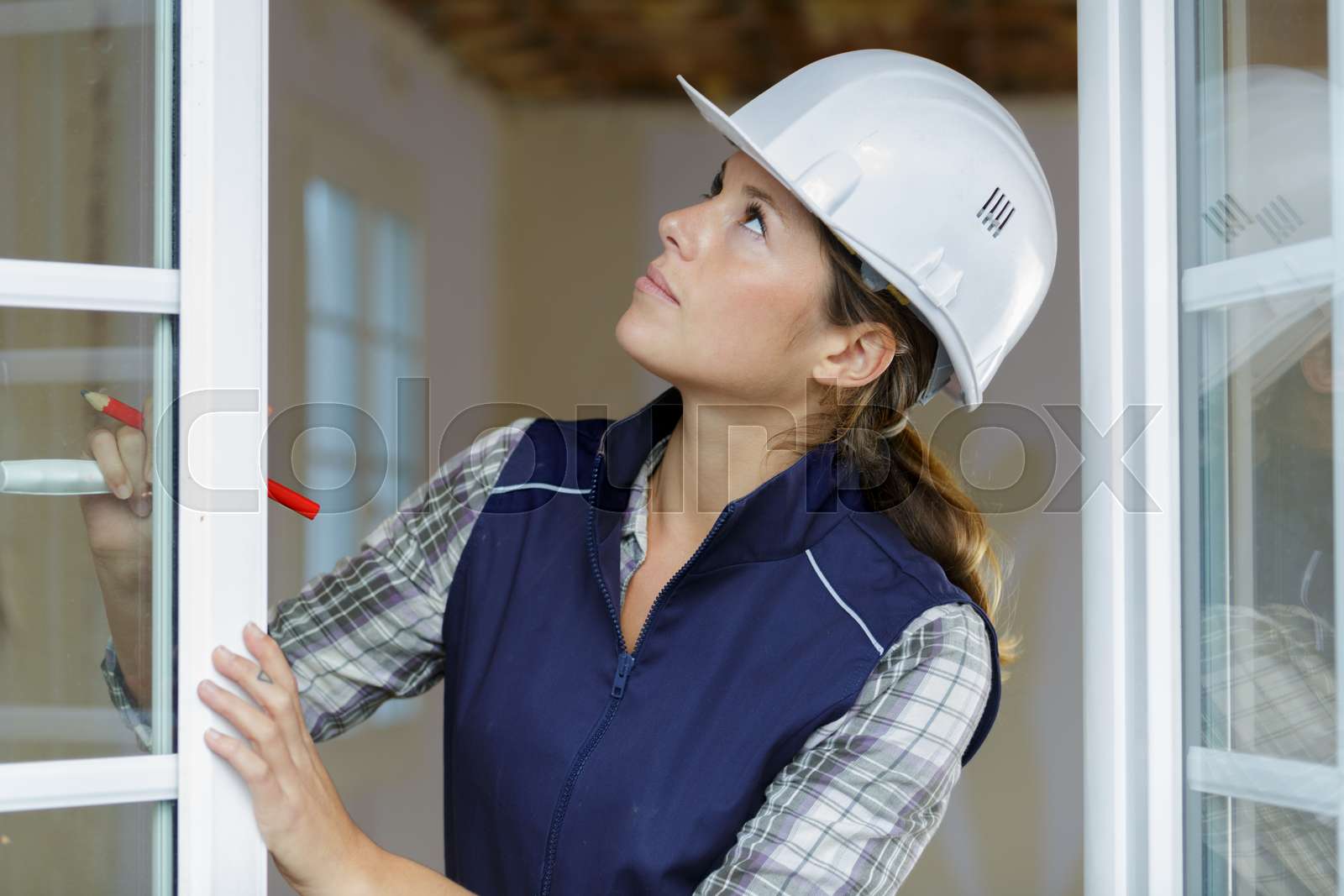 female window fitter at work | Stock image | Colourbox