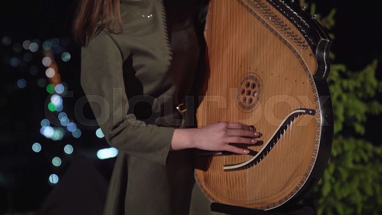 The musician plays the Ukrainian traditional bandura instrument on city ...