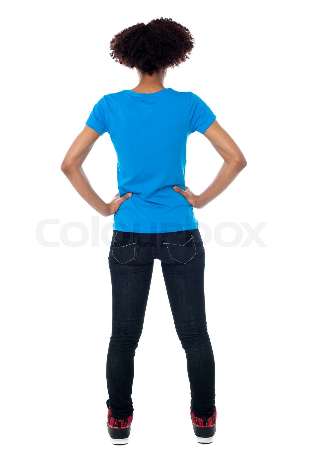 Back pose of young woman facing wall | Stock image | Colourbox