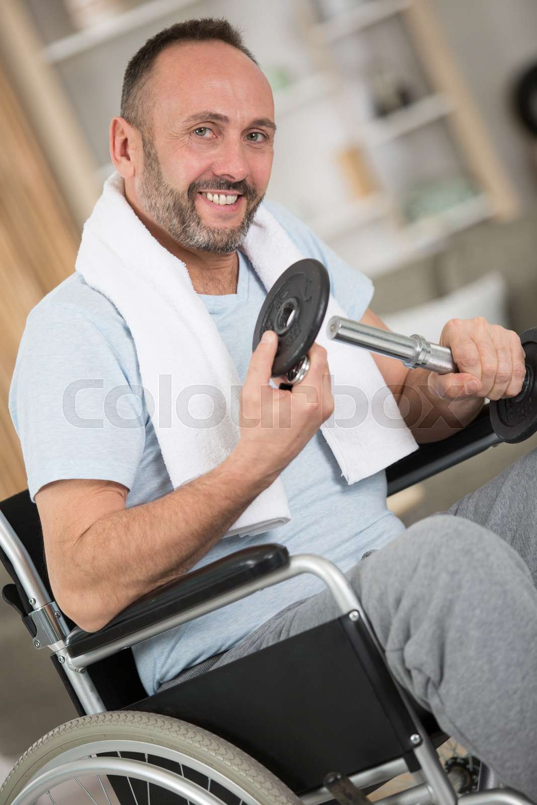 handsome disabled paraplegic man in wheelchair doing rehabilitation ...