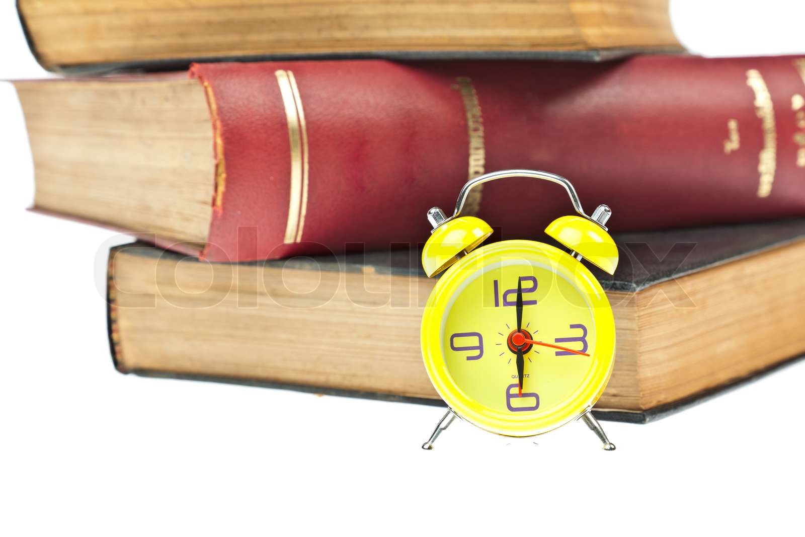 Clock and book as time management concept | Stock image | Colourbox