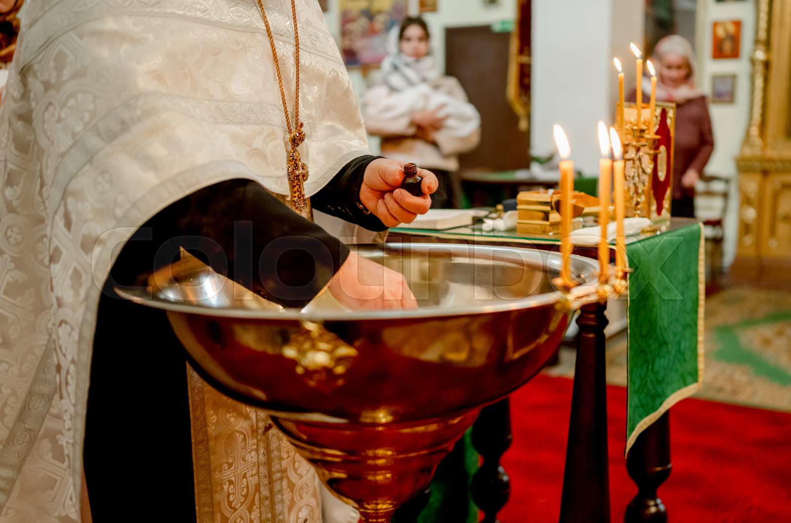 The priest's hand in the bath for the baptism of children | Stock image ...
