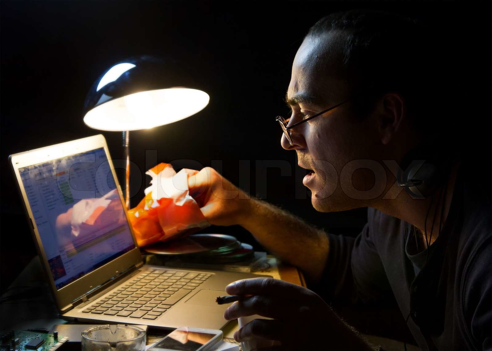 The man in front of a computer screen at night | Stock image | Colourbox