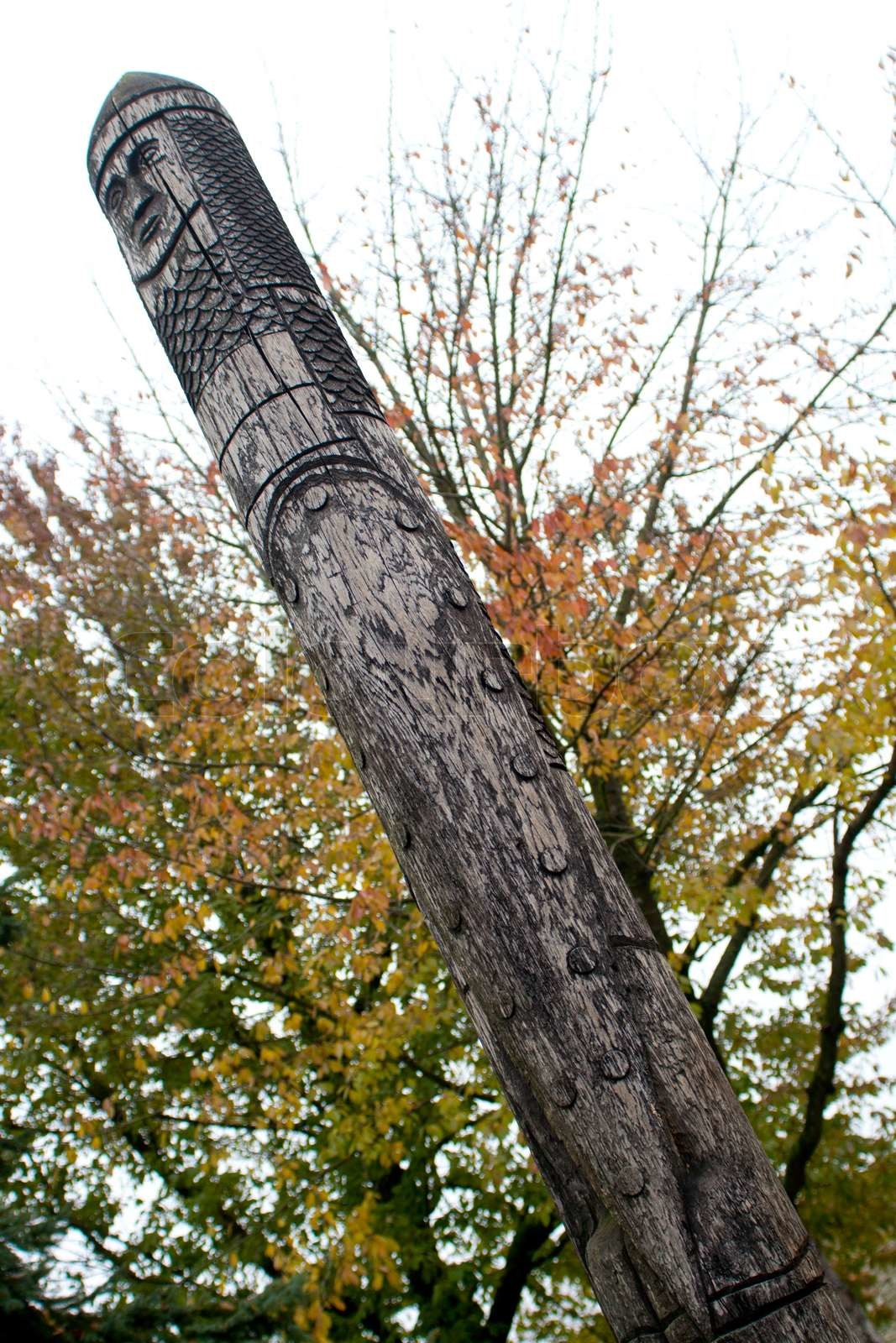 ancient wooden pole with a cut on it depicting ancient deities | Stock ...