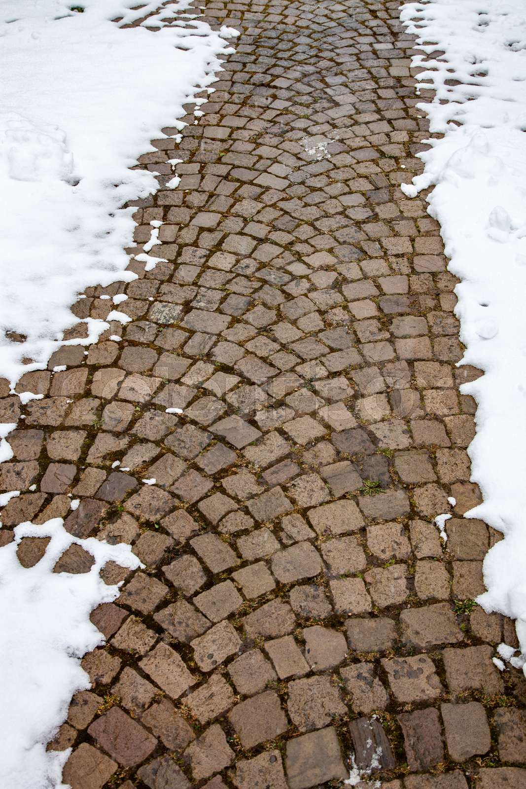 The cobblestones are covered with snow | Stock image | Colourbox