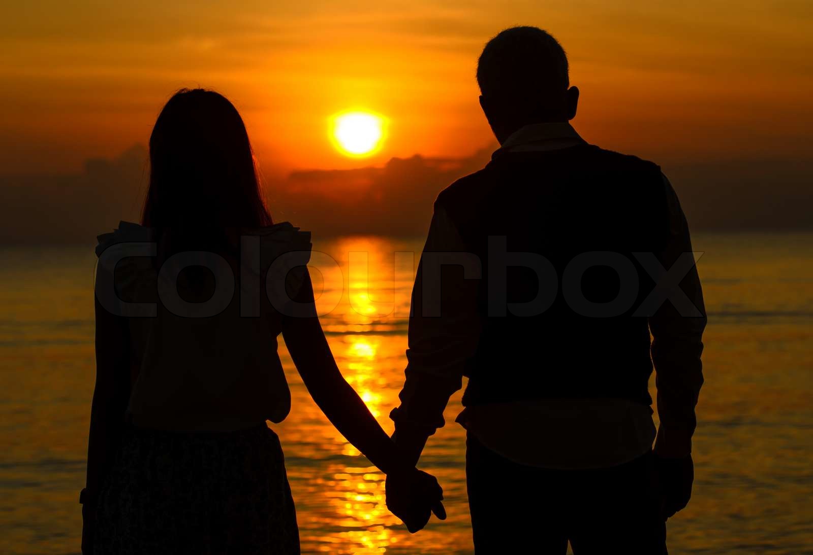 Couple of lover holding hand with sunrise | Stock image | Colourbox