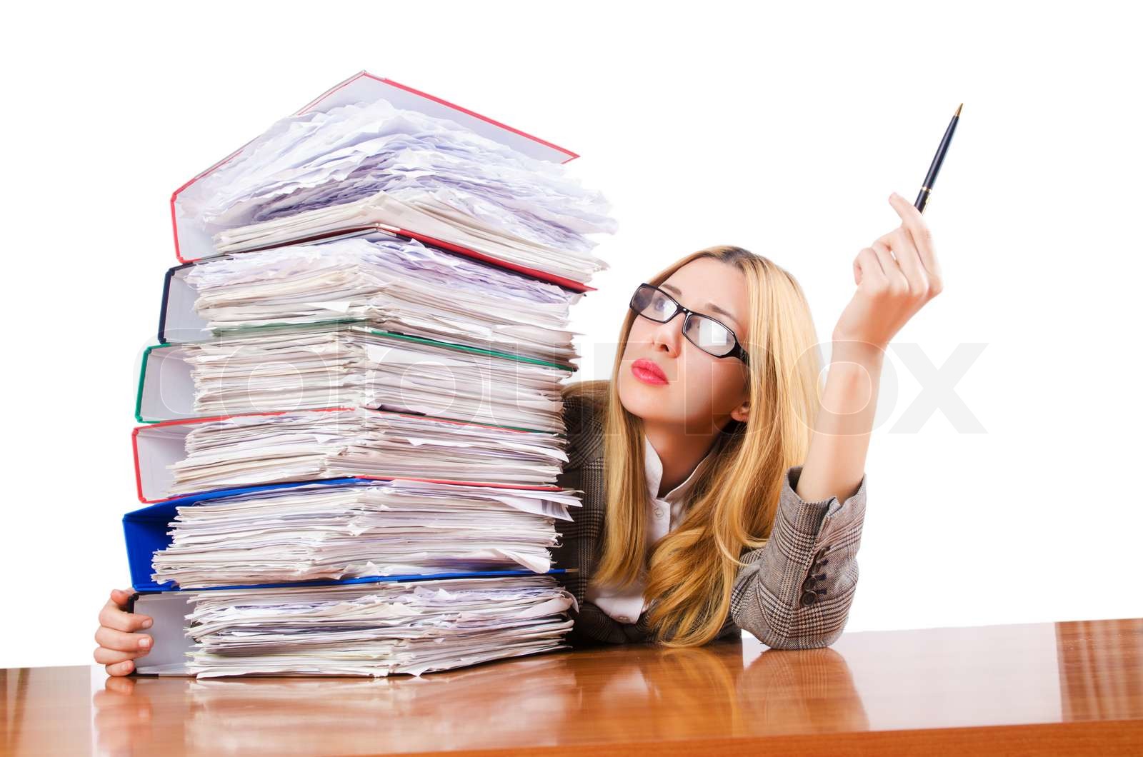 Busy woman with stacks of paper | Stock image | Colourbox