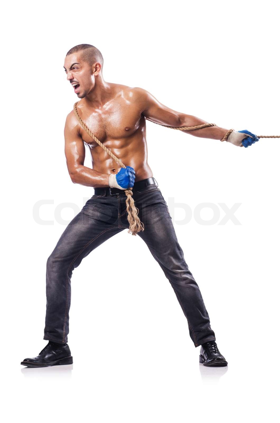 Muscular man pulling the rope | Stock image | Colourbox