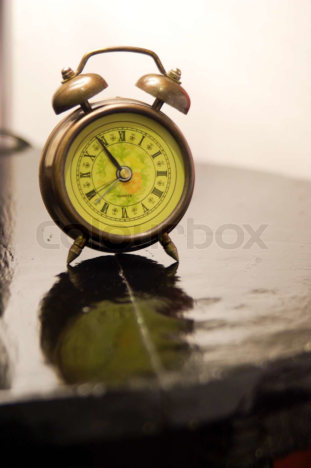 Vintage clock on wood table | Stock image | Colourbox