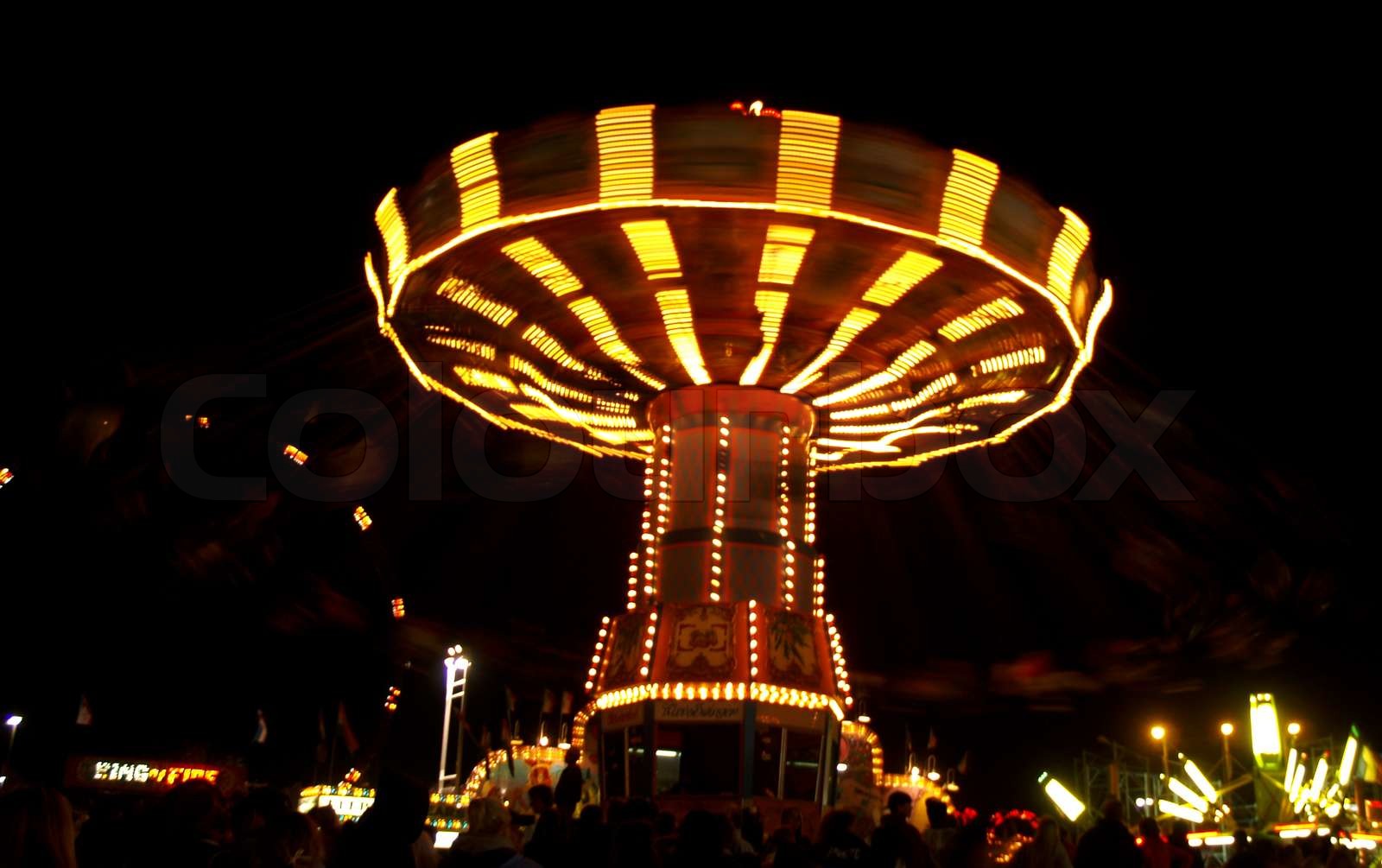 Colorful Spinning Ride at an Annual County Fair with Motion Blur ...