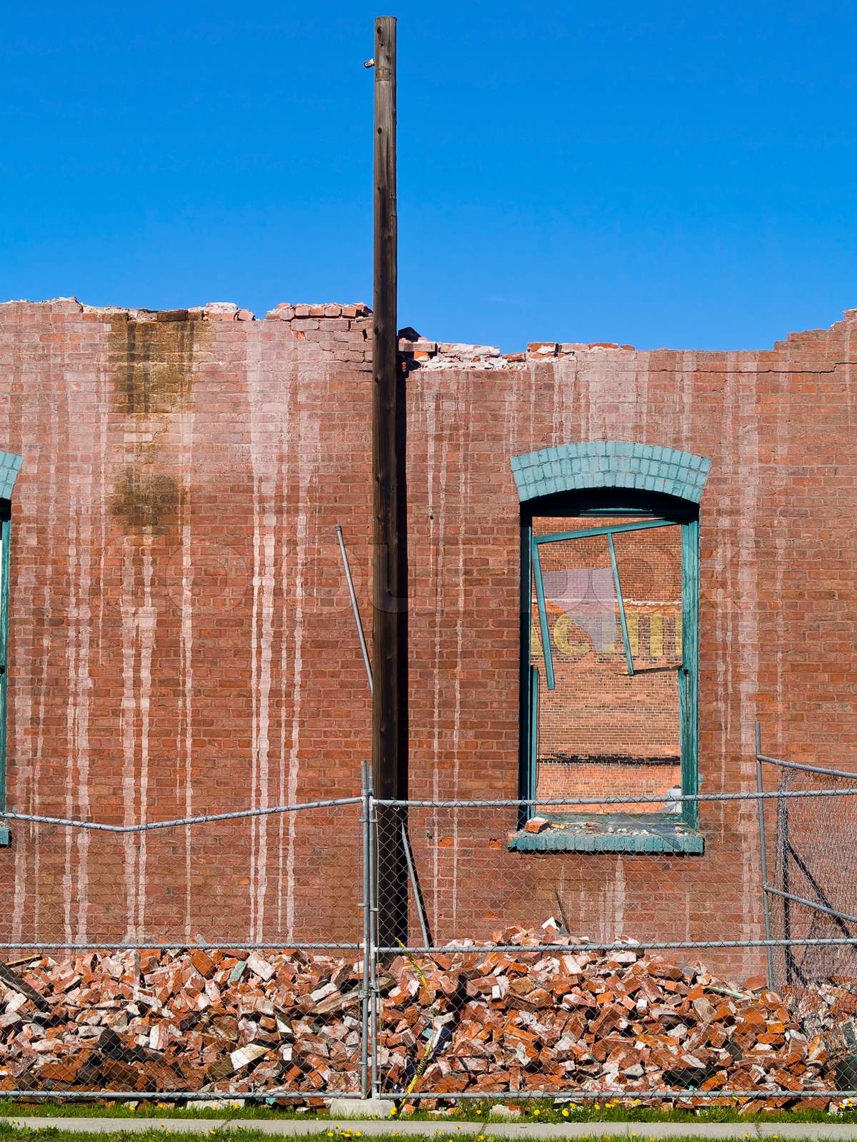 Brick wall and broken window at a demolition site | Stock image | Colourbox