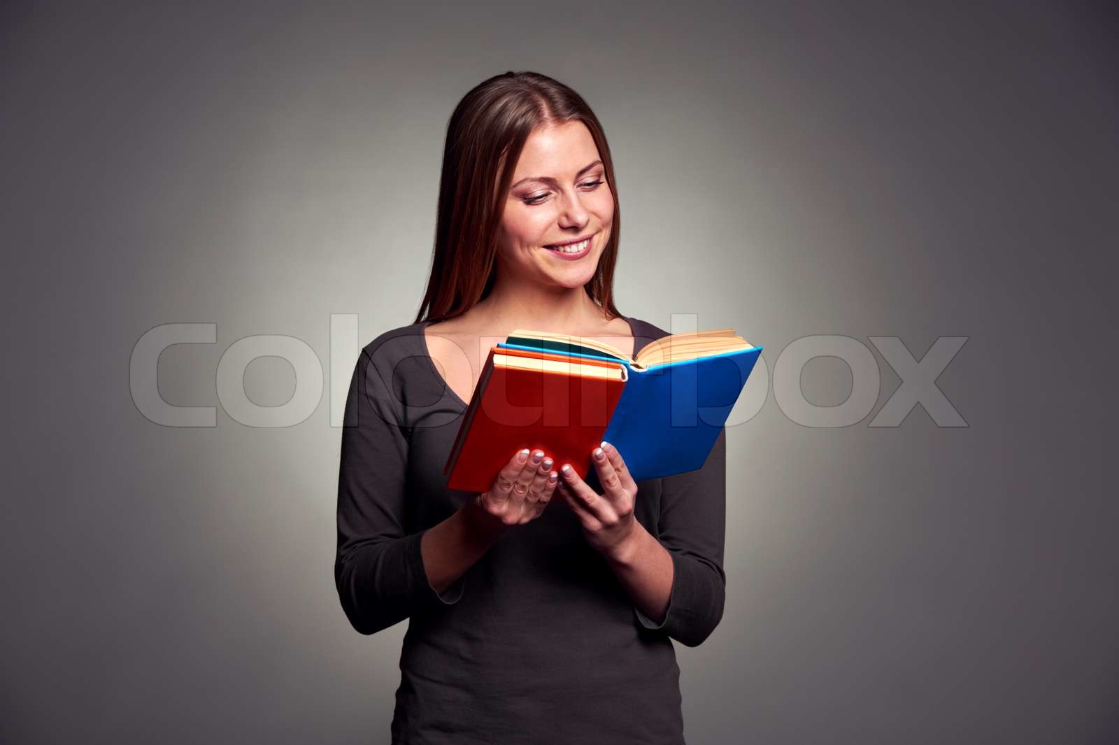 woman reading the book and smiling | Stock image | Colourbox