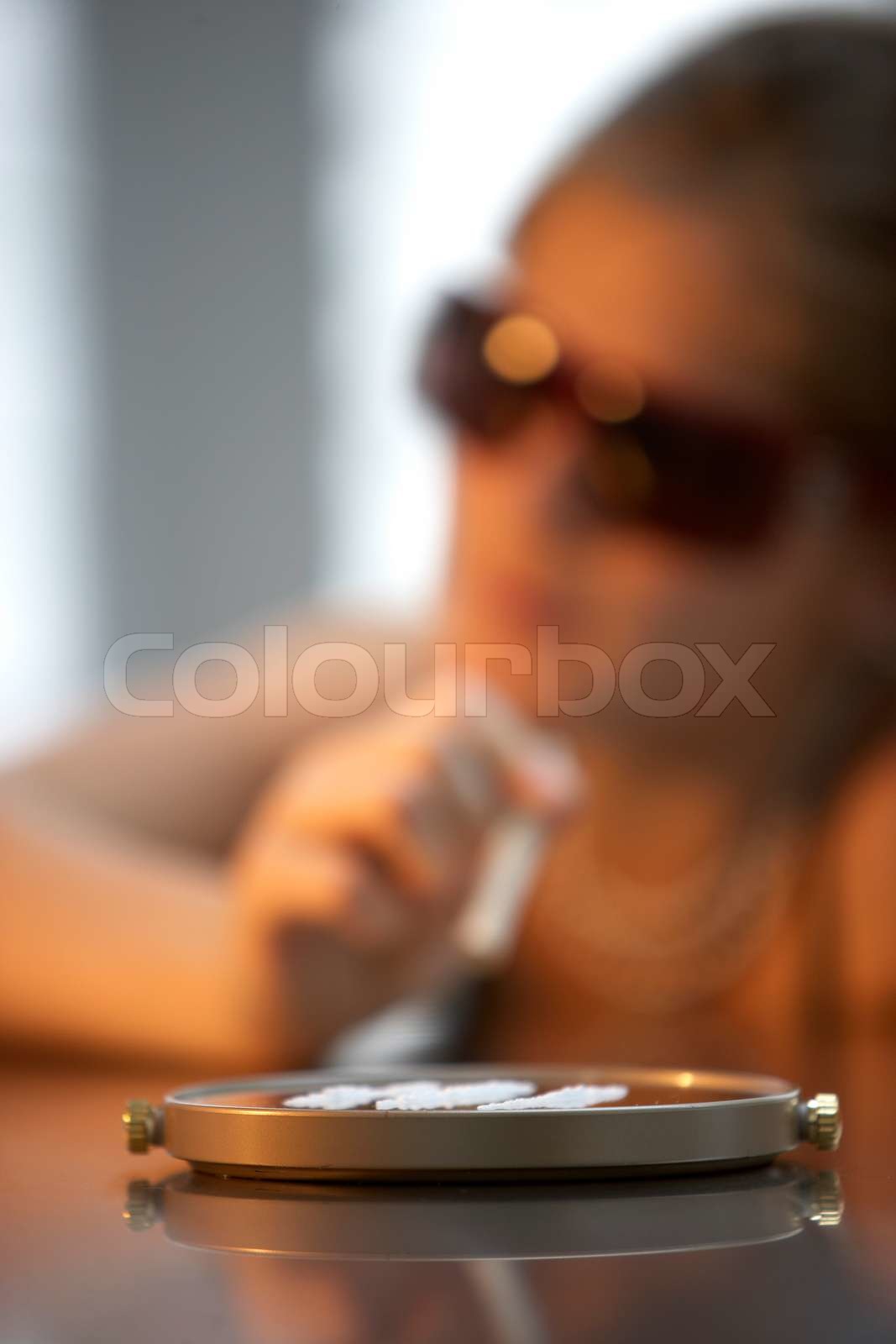 A rich caucasian woman snorting cocaine | Stock image | Colourbox