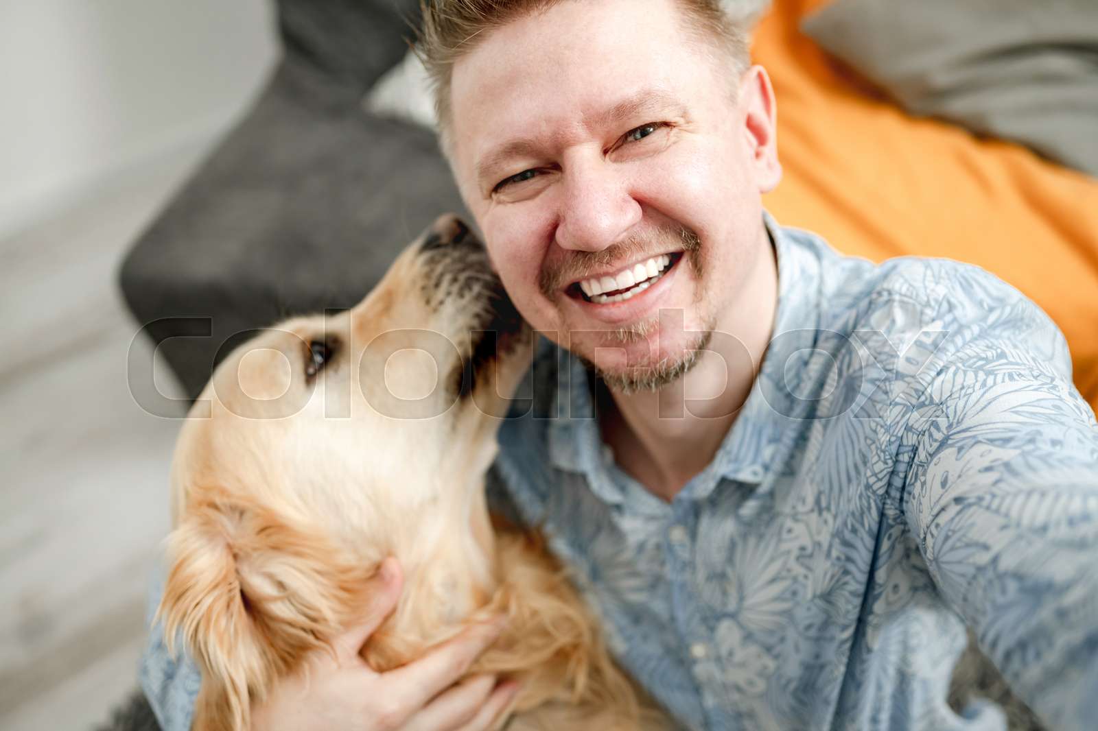 Smiling guy man with golden retriever dog | Stock image | Colourbox