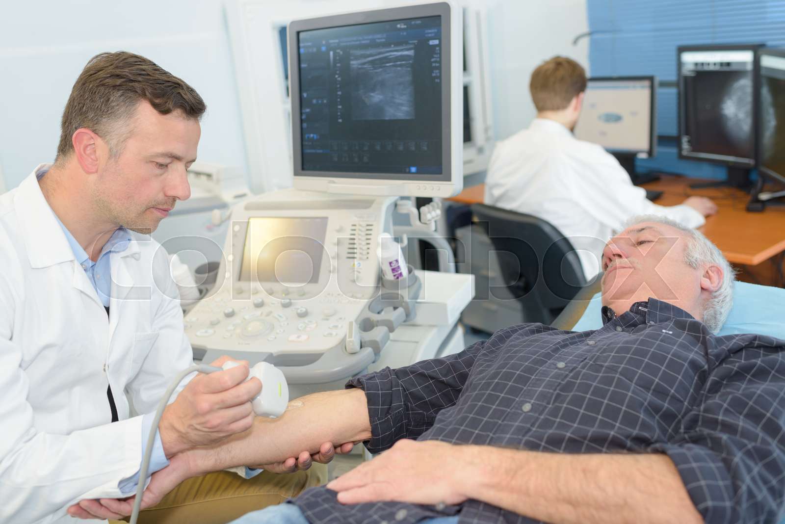 patient having an ultrasound on the arm | Stock image | Colourbox