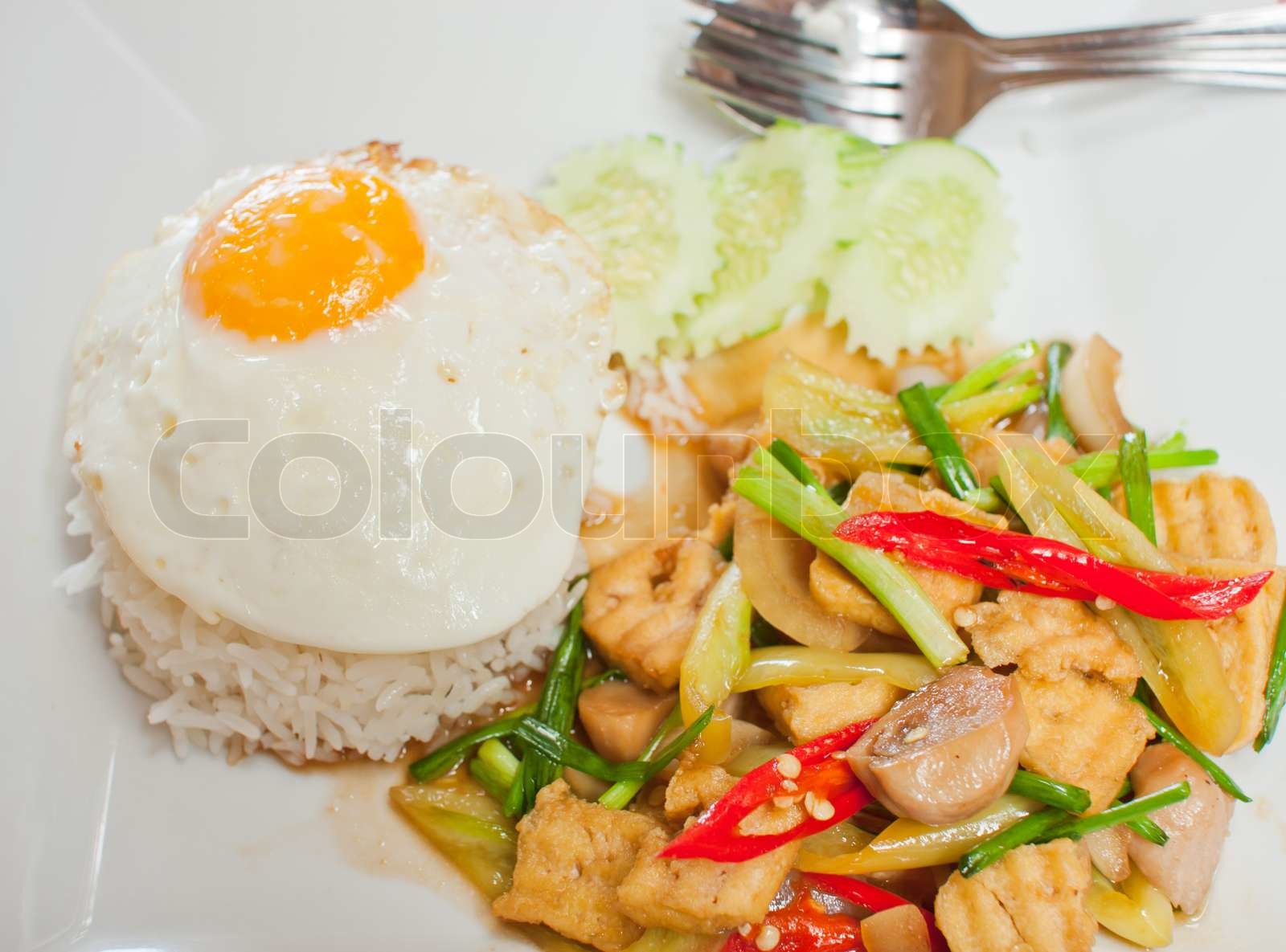 sunny-side up egg on rice with spicy fried vegetable and pork slice ...