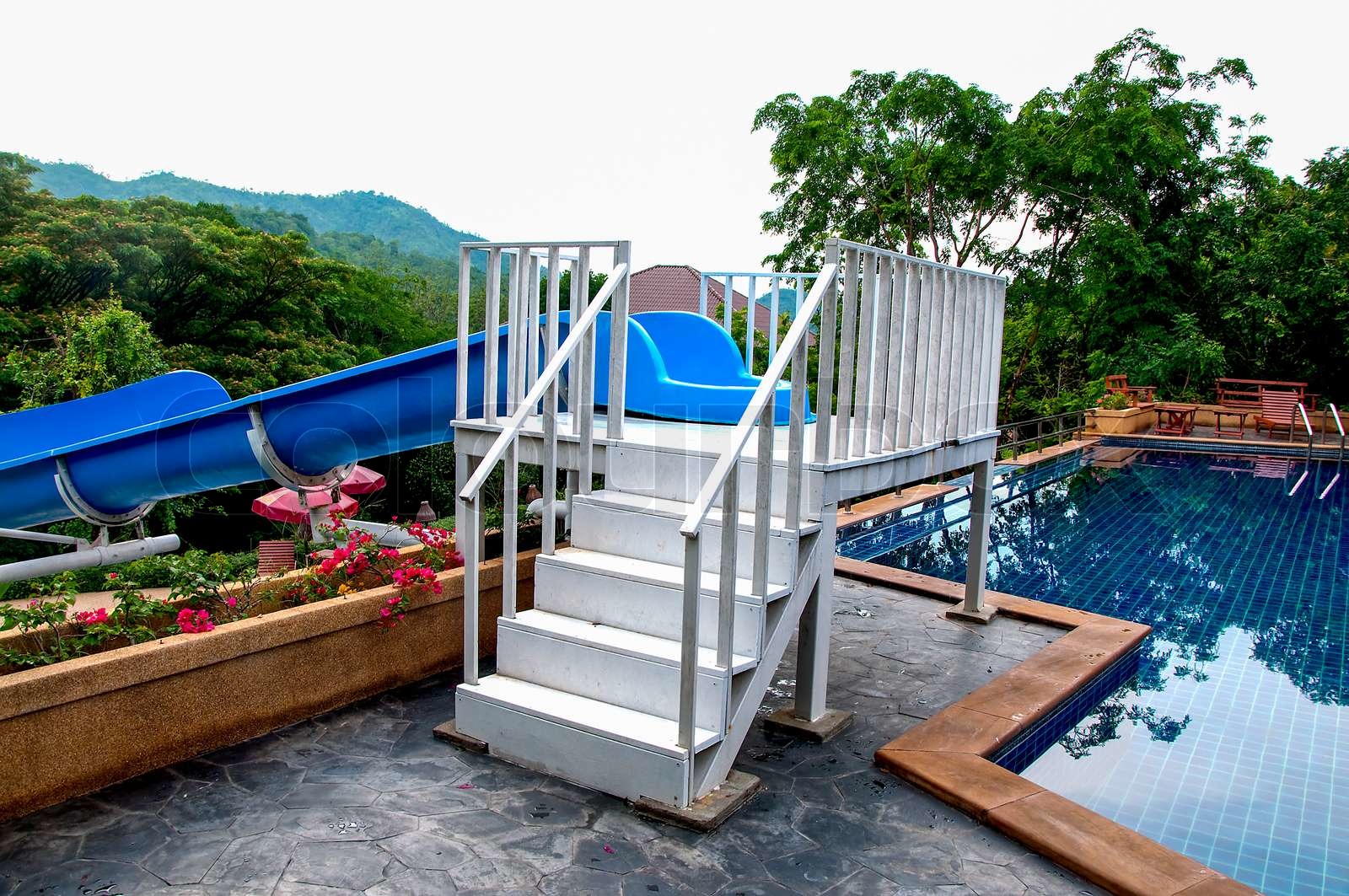 The Wooden staircase to water slide tube to the pool | Stock image ...