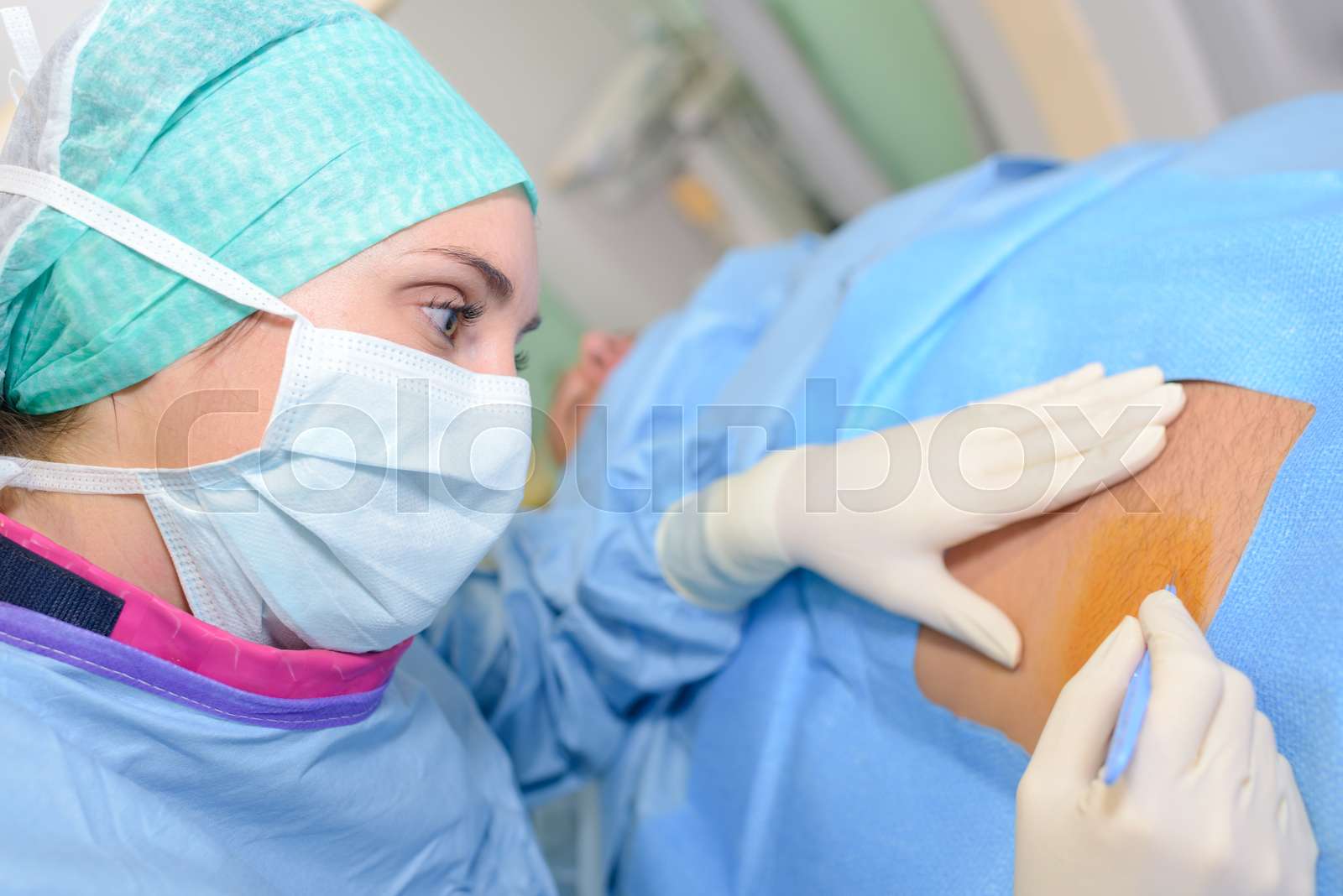 Surgeon poised to cut body with scalpel | Stock image | Colourbox
