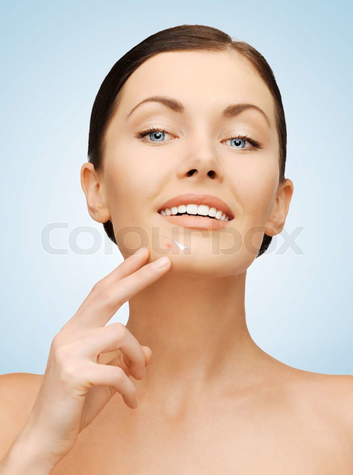 beautiful woman pointing to chin | Stock image | Colourbox