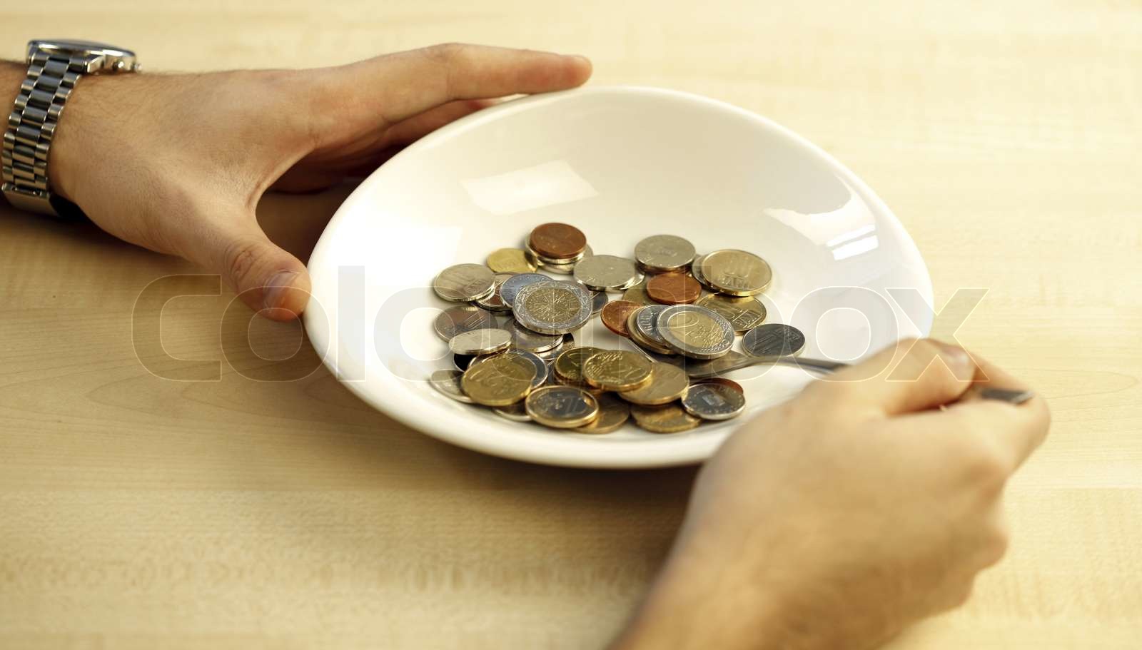 Eating some coins | Stock image | Colourbox