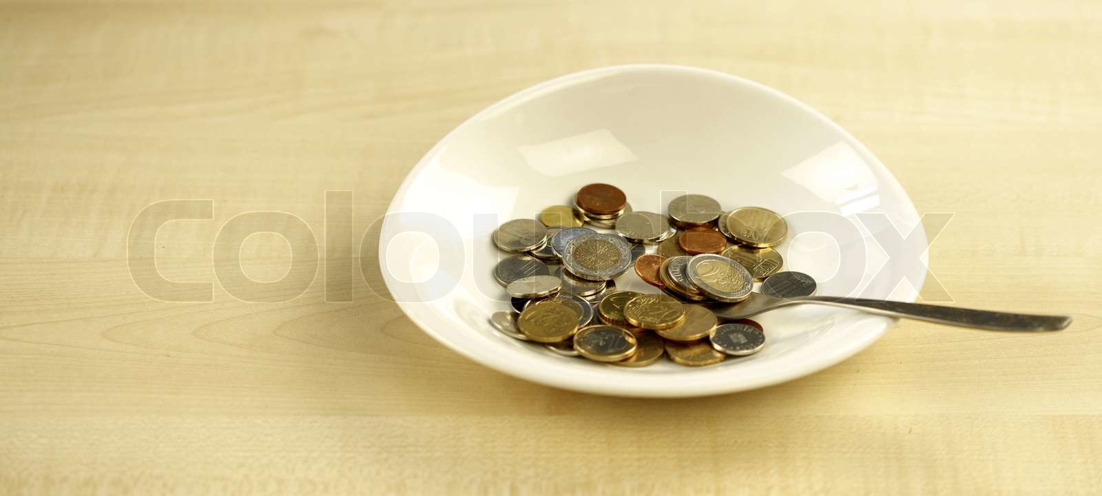 Eating some coins | Stock image | Colourbox