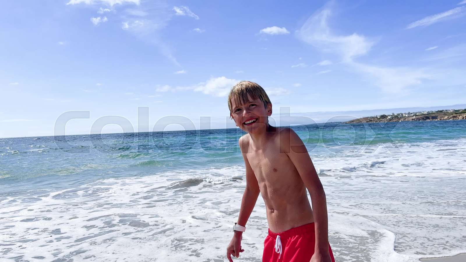 Happy laughing smiling boy on beach with camera turn around | Stock ...