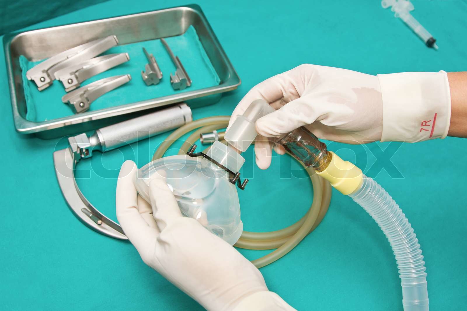 Set of tools for intubation tracheas with a hand of doctor connecting ...