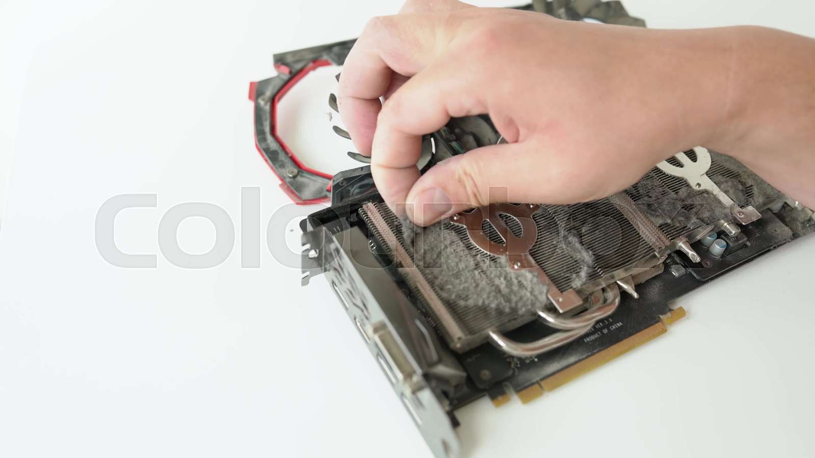 Cleaning the computer video card from caked dust. Close-up computer ...