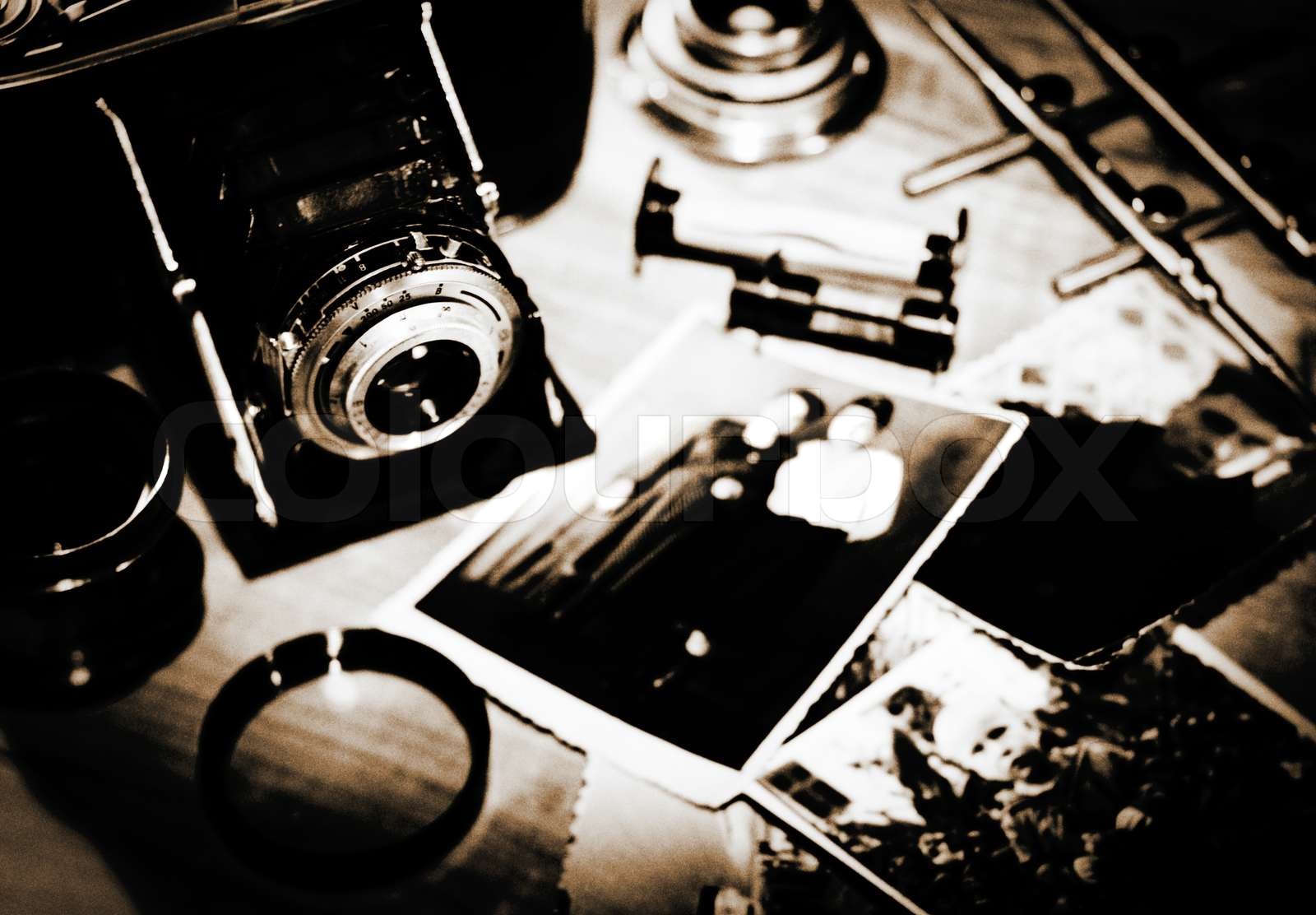 Vintage still life with retro photo camera and old photos | Stock image ...