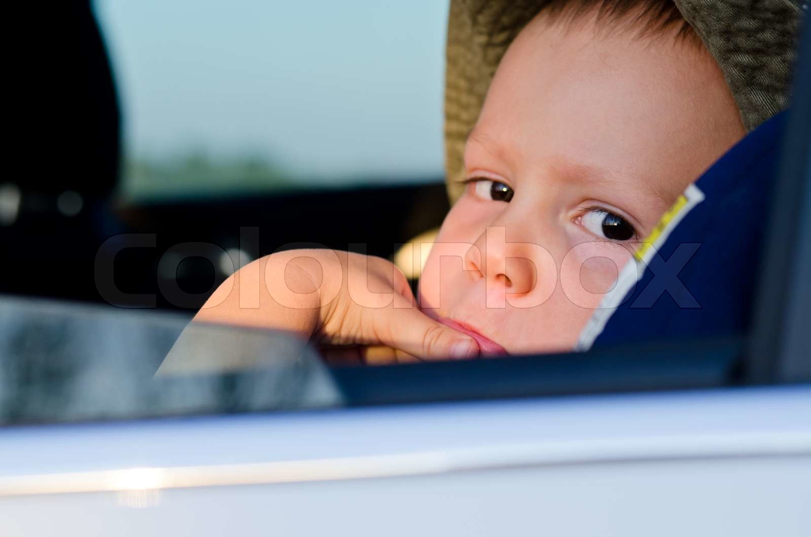 Bored little boy in a car | Stock image | Colourbox
