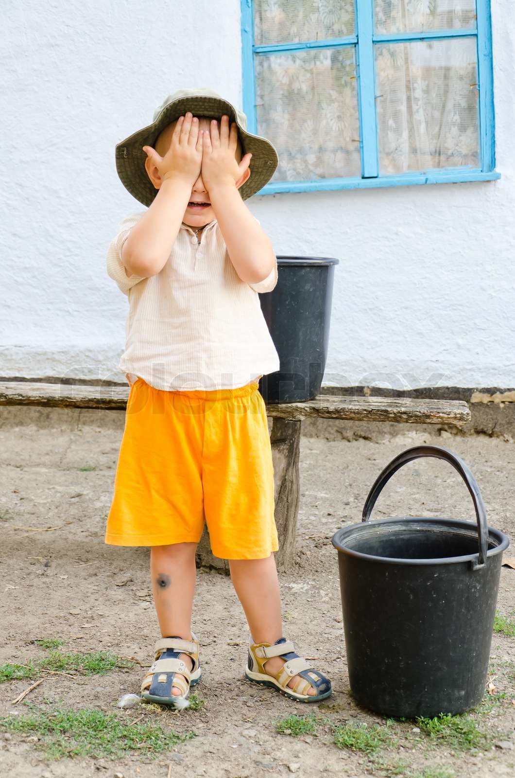 Cute little boy covering his face | Stock image | Colourbox