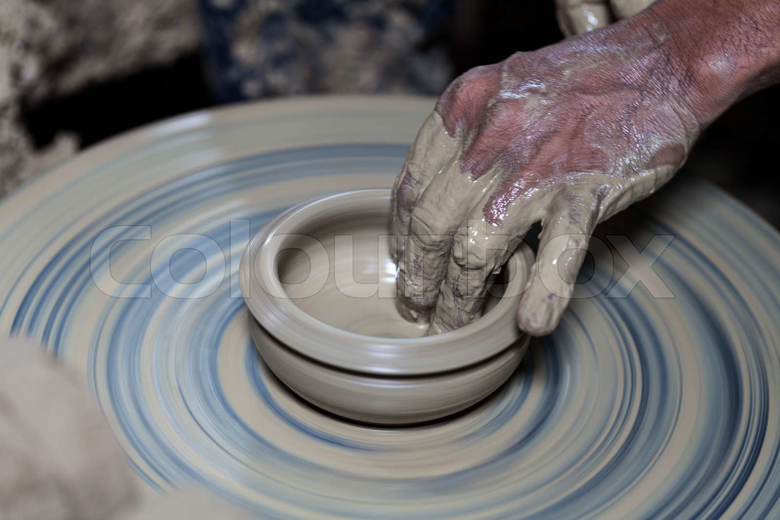 hands on a piece of pottery made of clay | Stock image | Colourbox