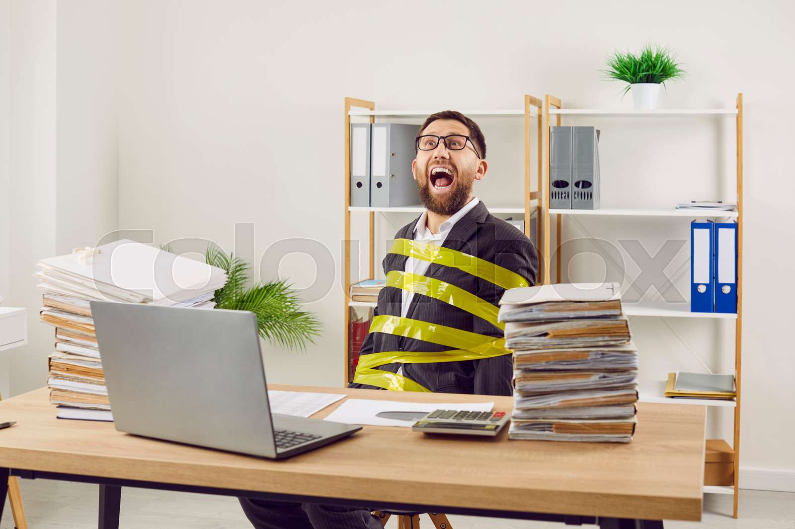 Funny male employee who is trapped at work in office is asking for help ...