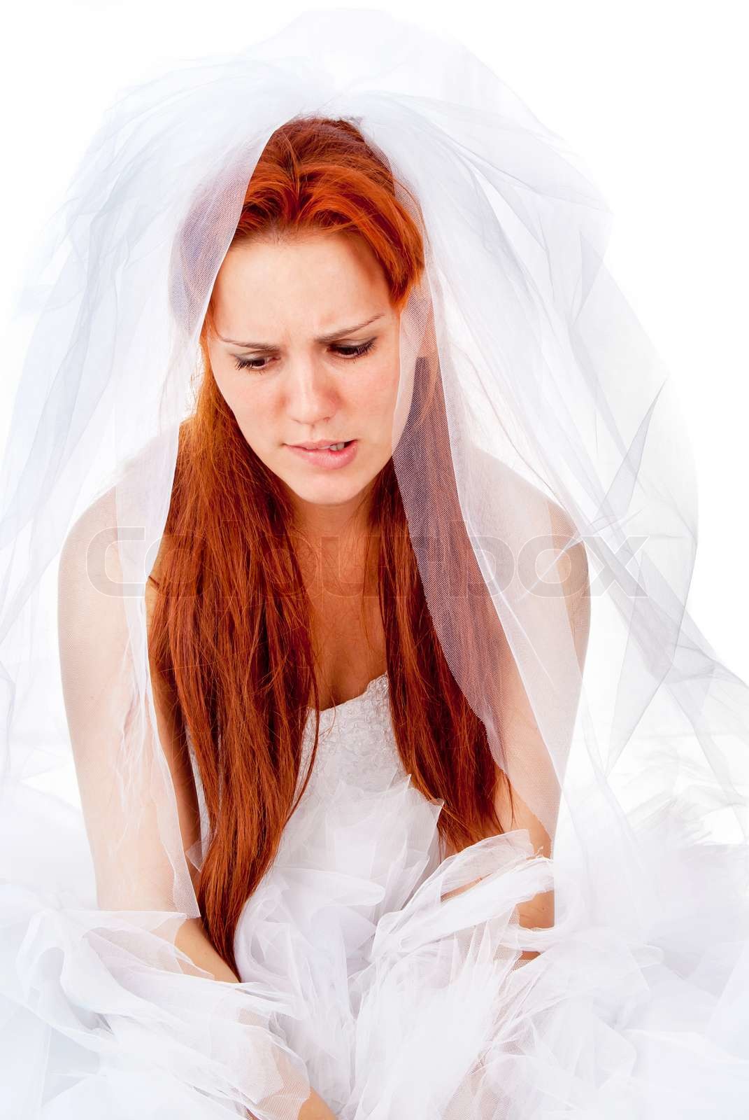a beautiful red-haired bride cries | Stock image | Colourbox
