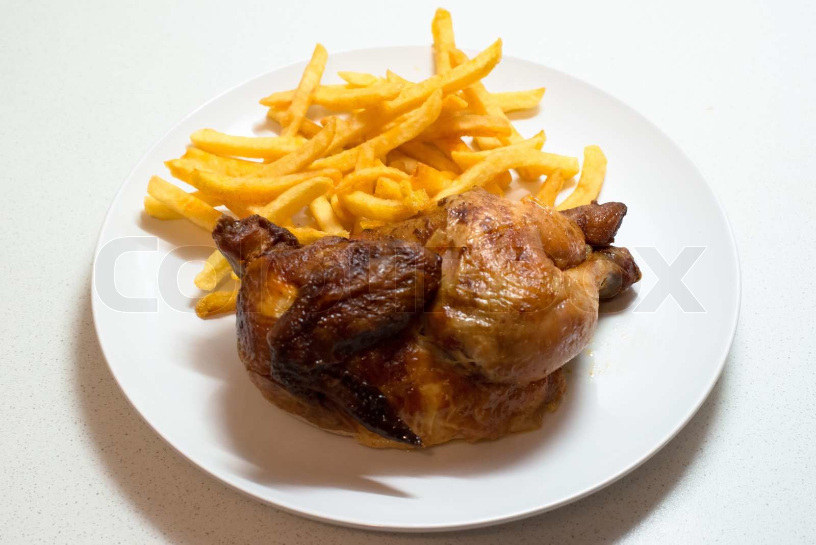 Chicken roasted with fries | Stock image | Colourbox