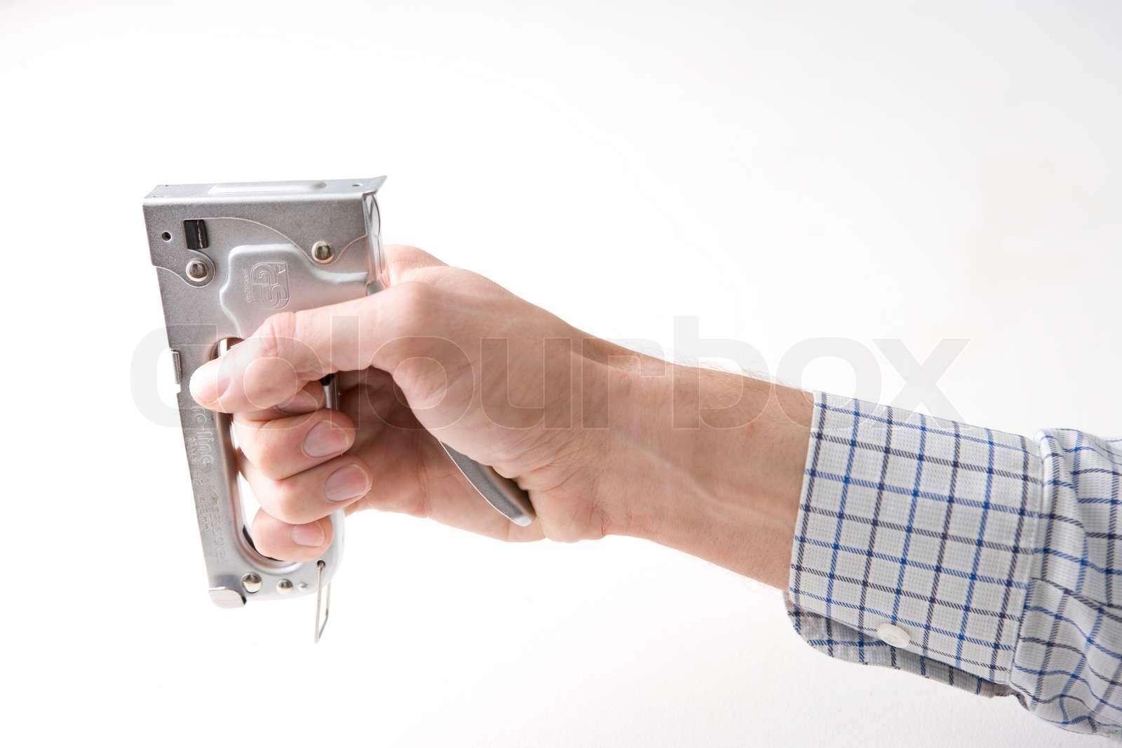 A man holding a staple gun | Stock image | Colourbox