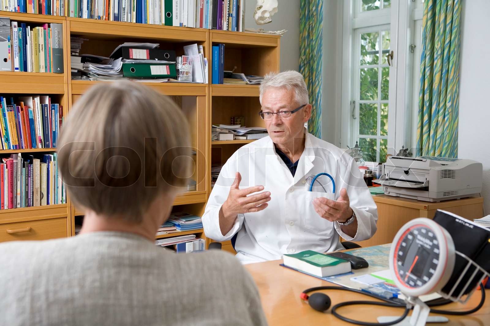 A family doctor giving advice to a patient | Stock image | Colourbox
