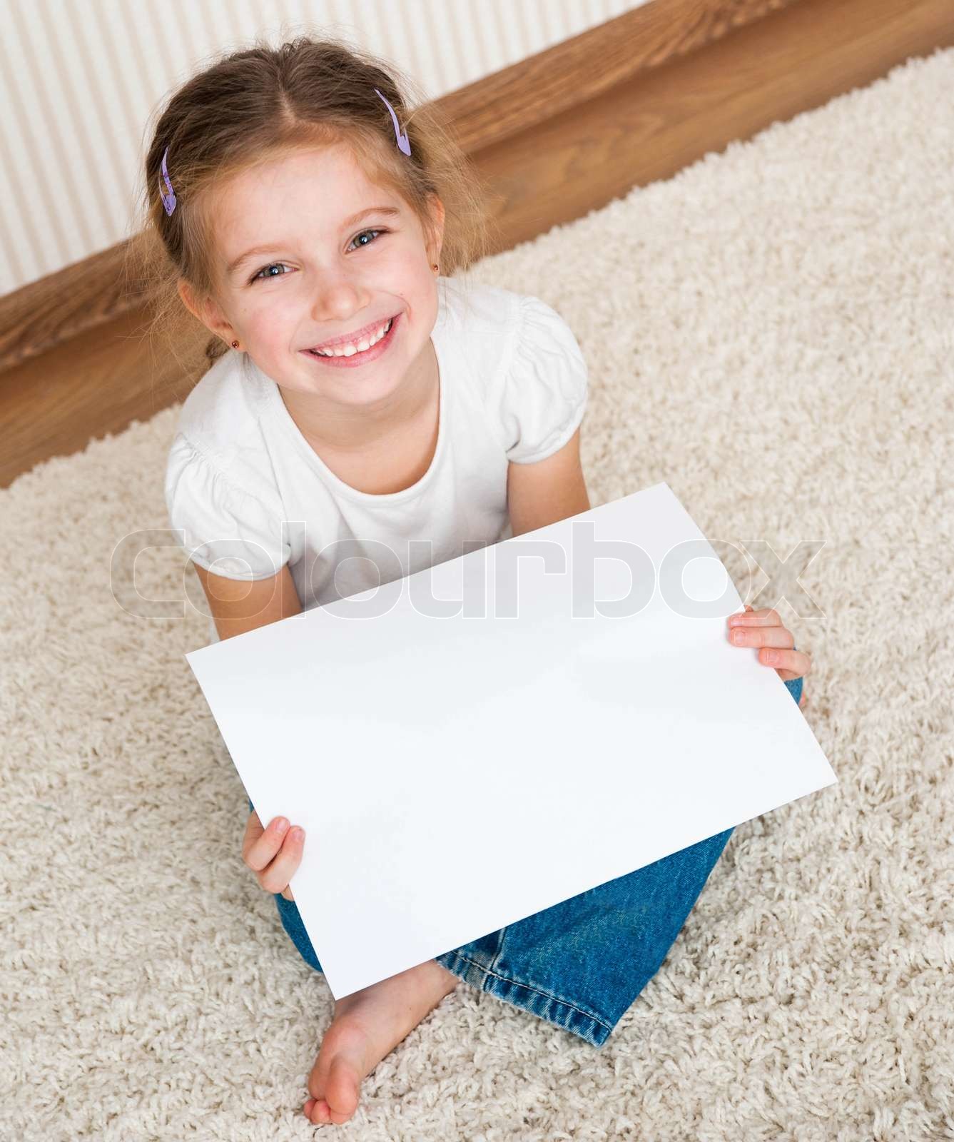 little girl with the sheet of paper | Stock image | Colourbox