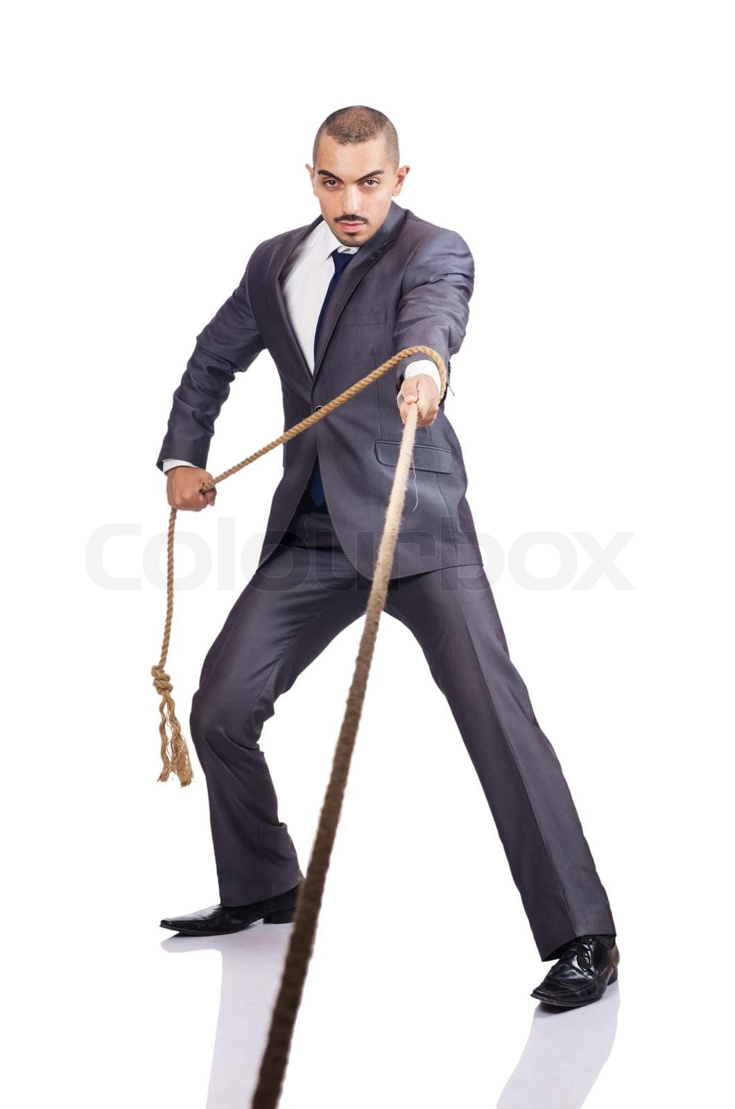 Man pulling the rope on white | Stock image | Colourbox