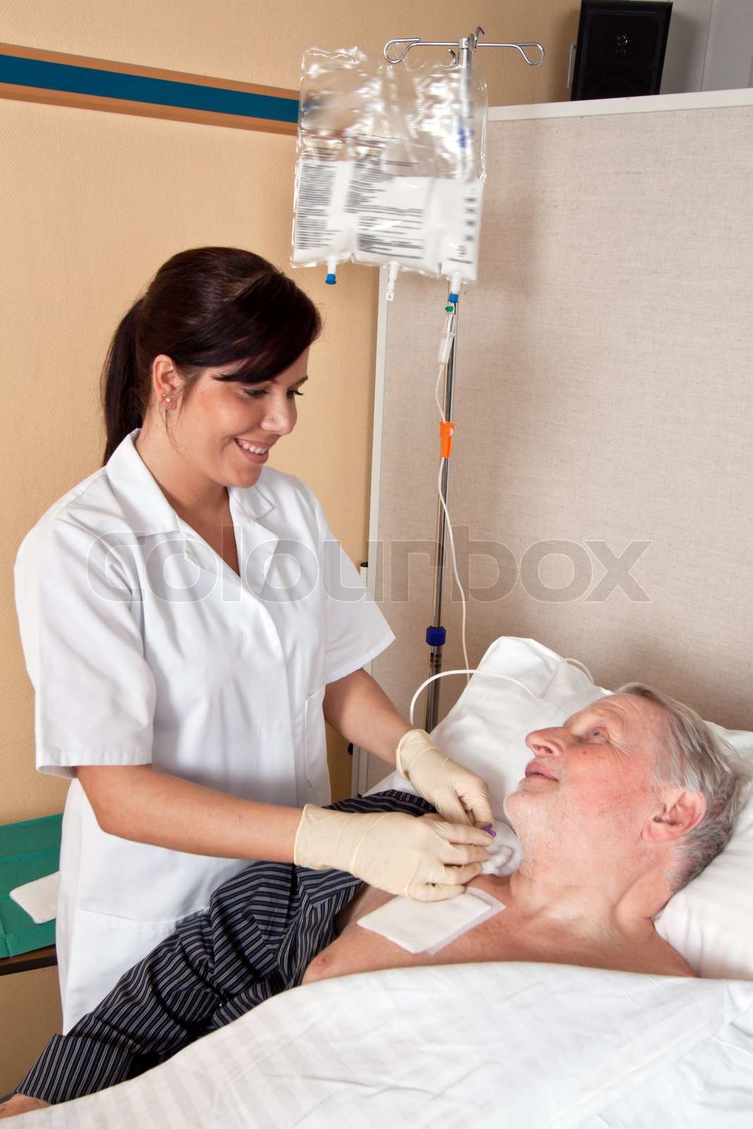 nurse gives a patient an infusion | Stock image | Colourbox