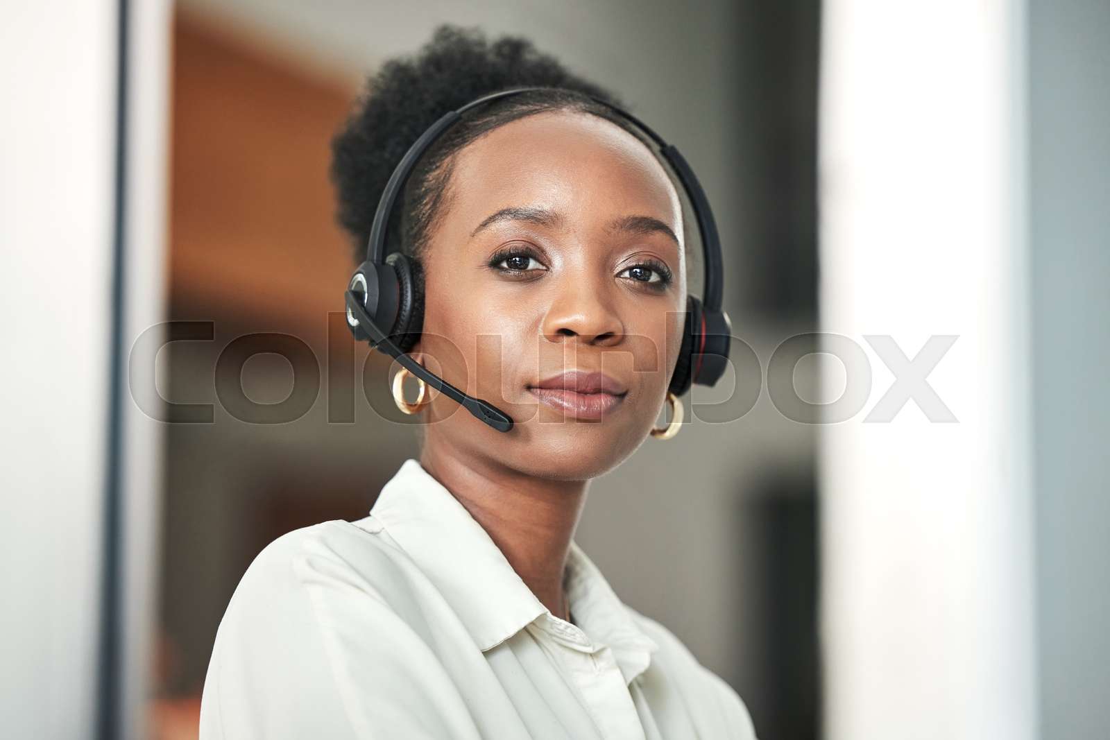 I take my job seriously. Shot of an attractive young call centre agent ...