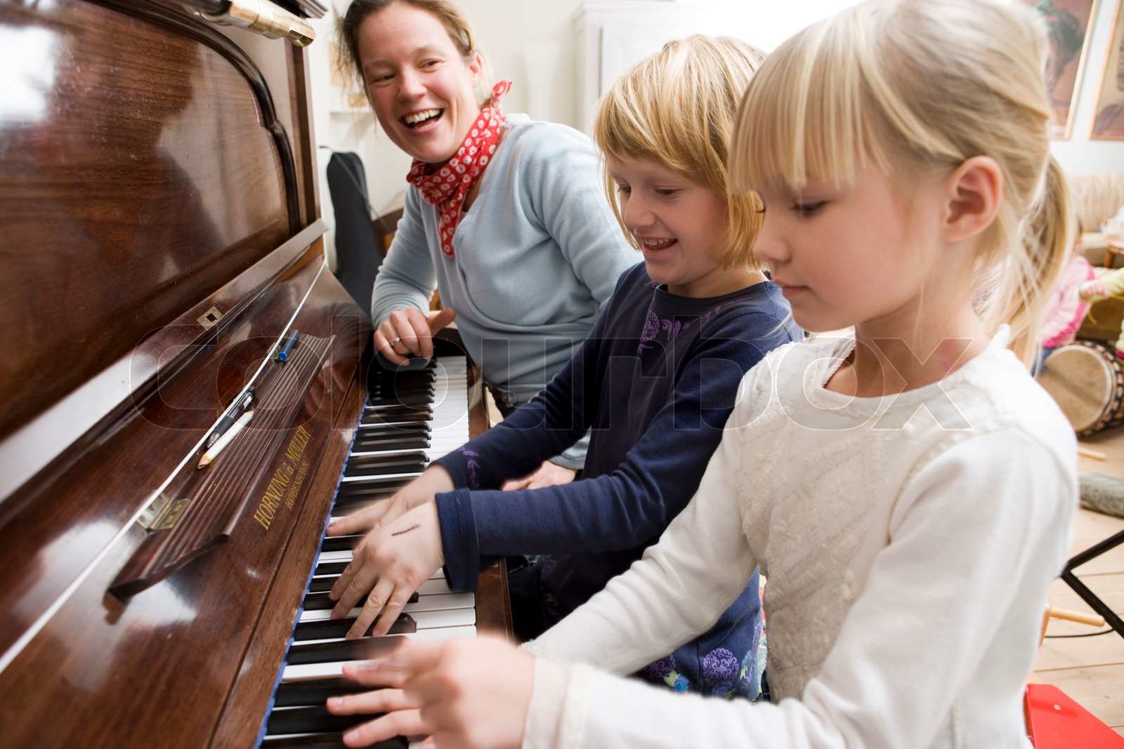 Young girls learning to play the piano | Stock image | Colourbox