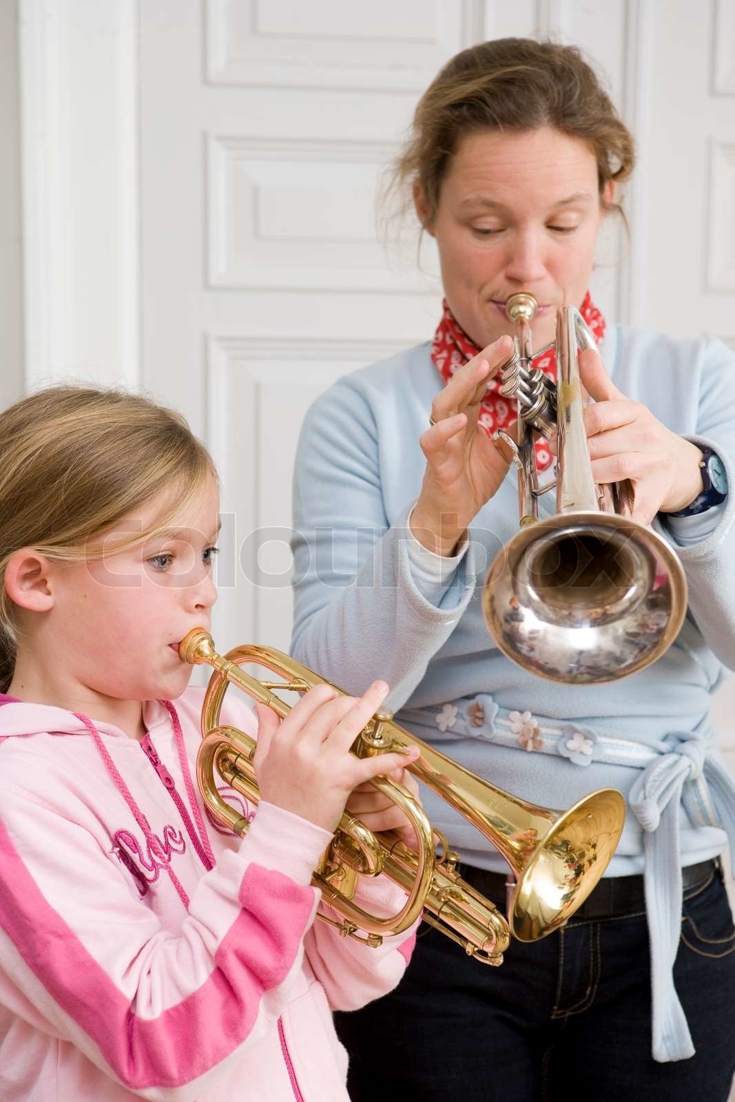 A young girl learning to play the trumpet | Stock image | Colourbox