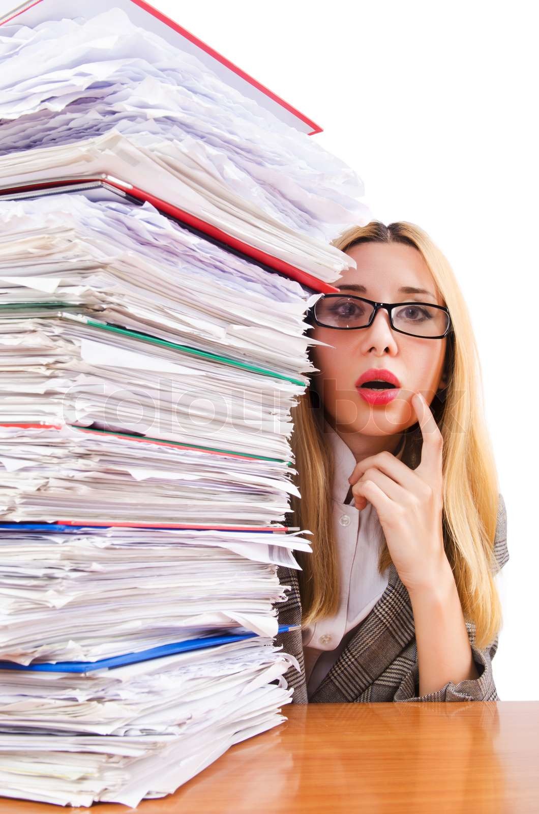 Busy woman with stacks of paper | Stock image | Colourbox