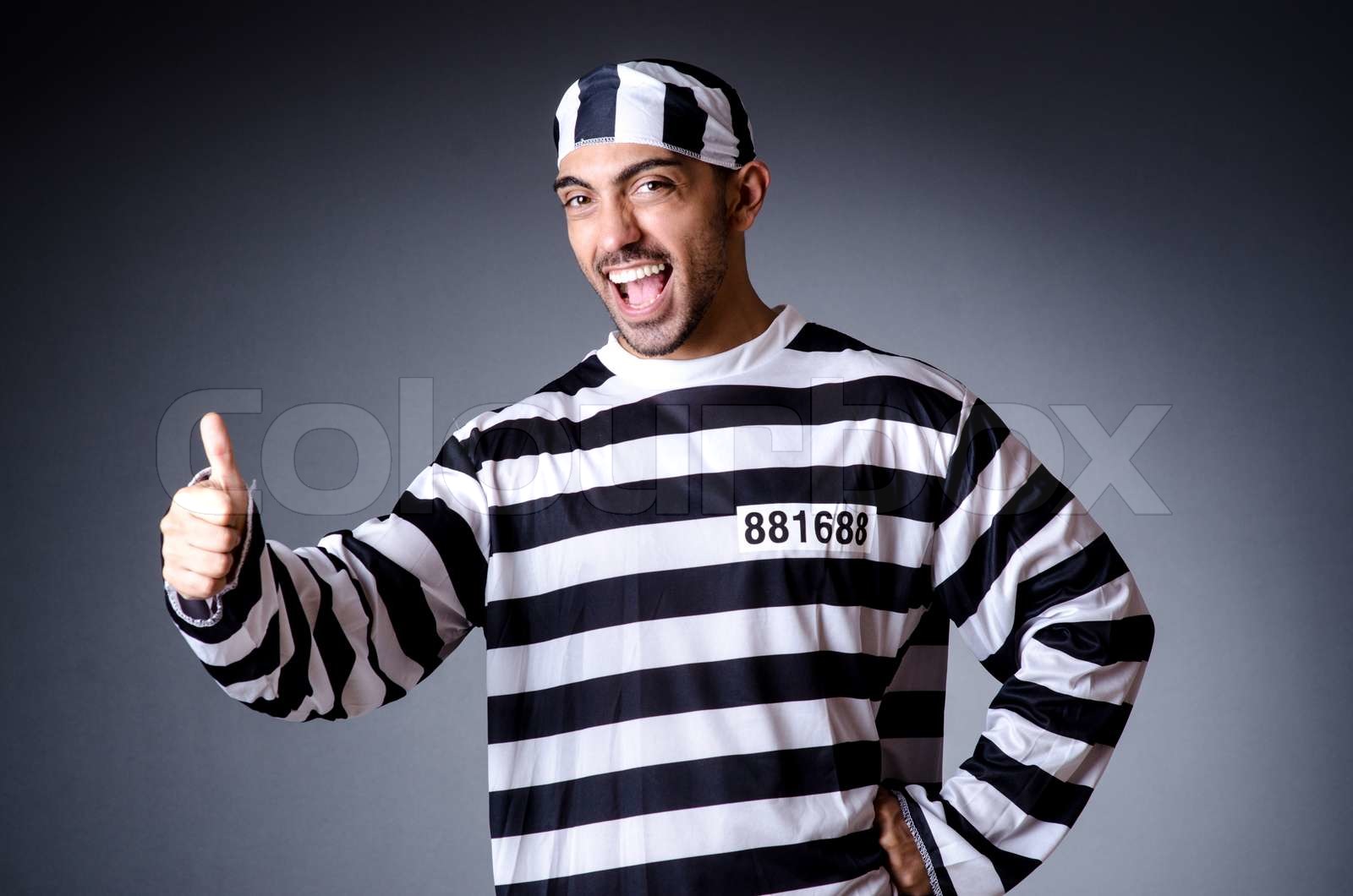 Convict criminal in striped uniform | Stock image | Colourbox
