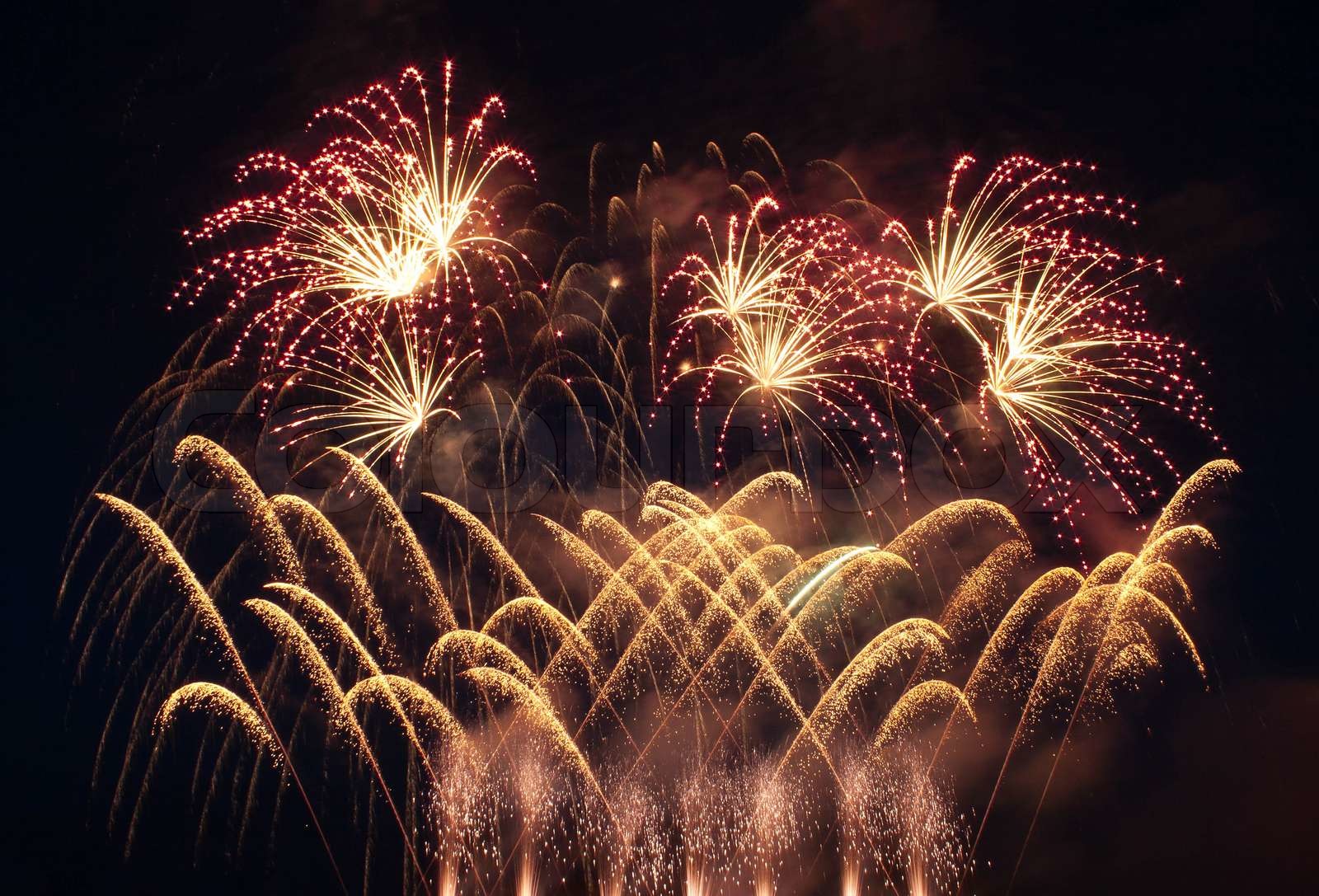Colorful fireworks over dark sky, displayed during a celebration ...